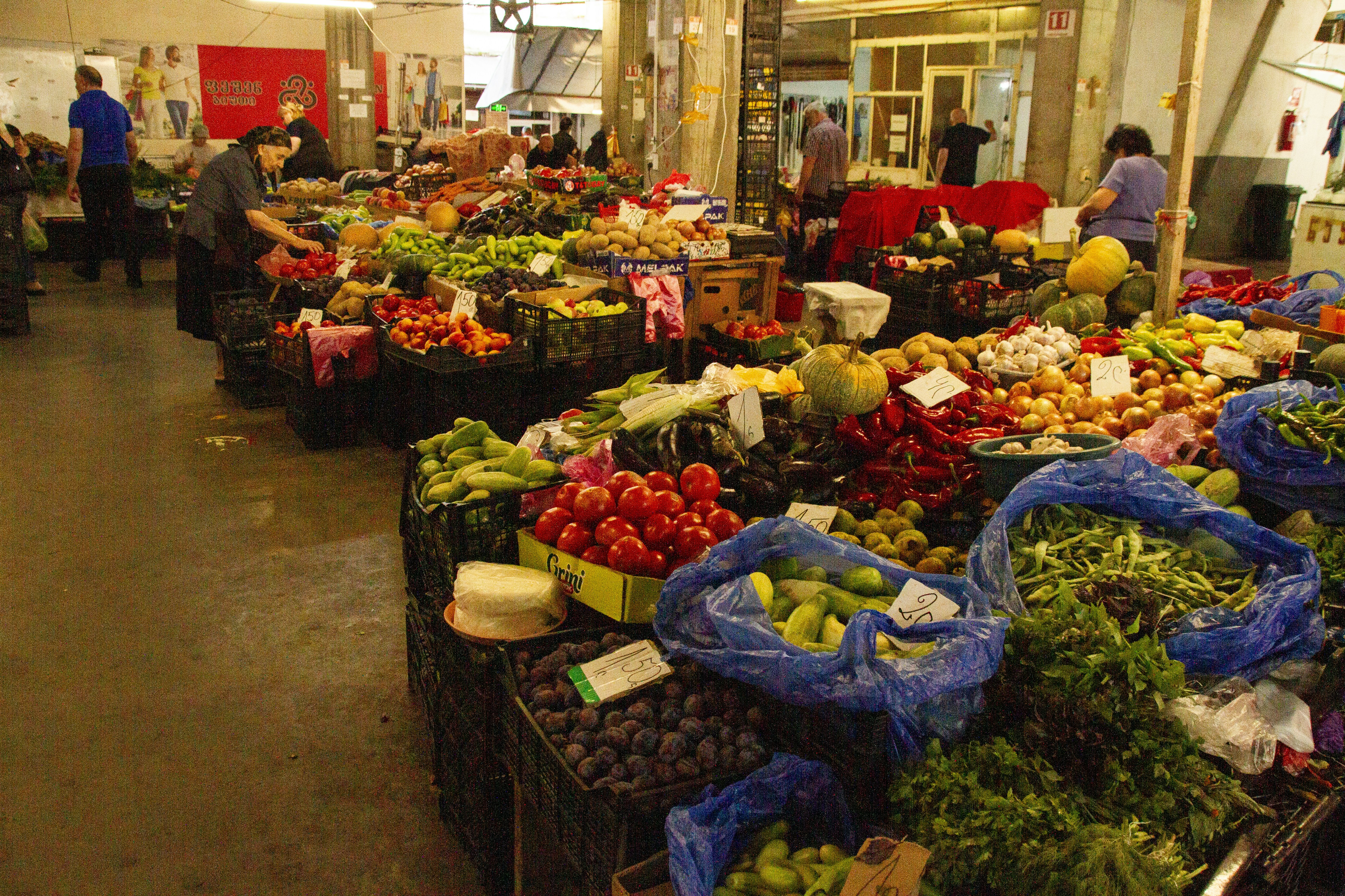Colorful Aisle of Fresh Harvests at a Busy Market