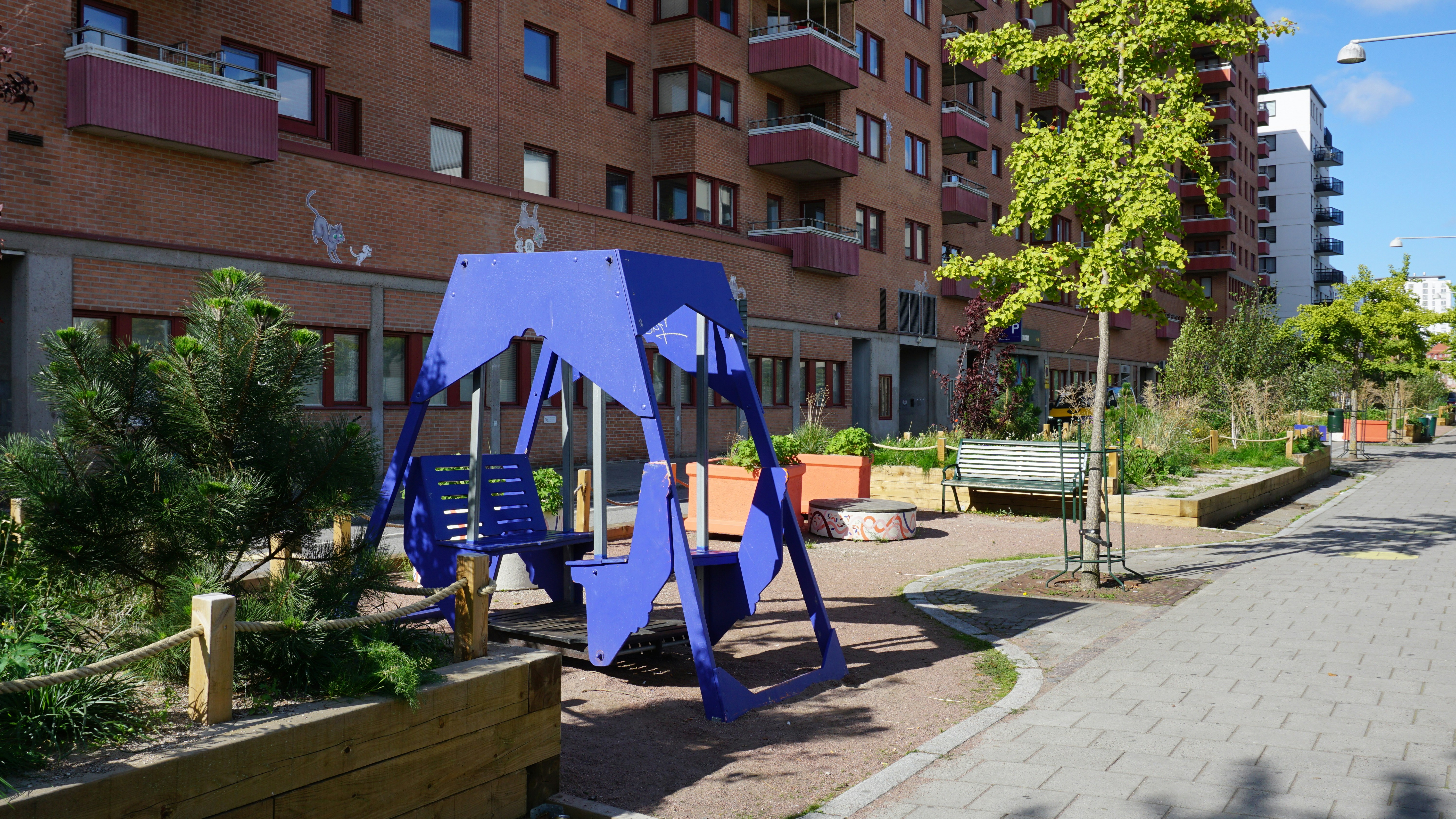 Blue Playground Structure Amid Urban Oasis