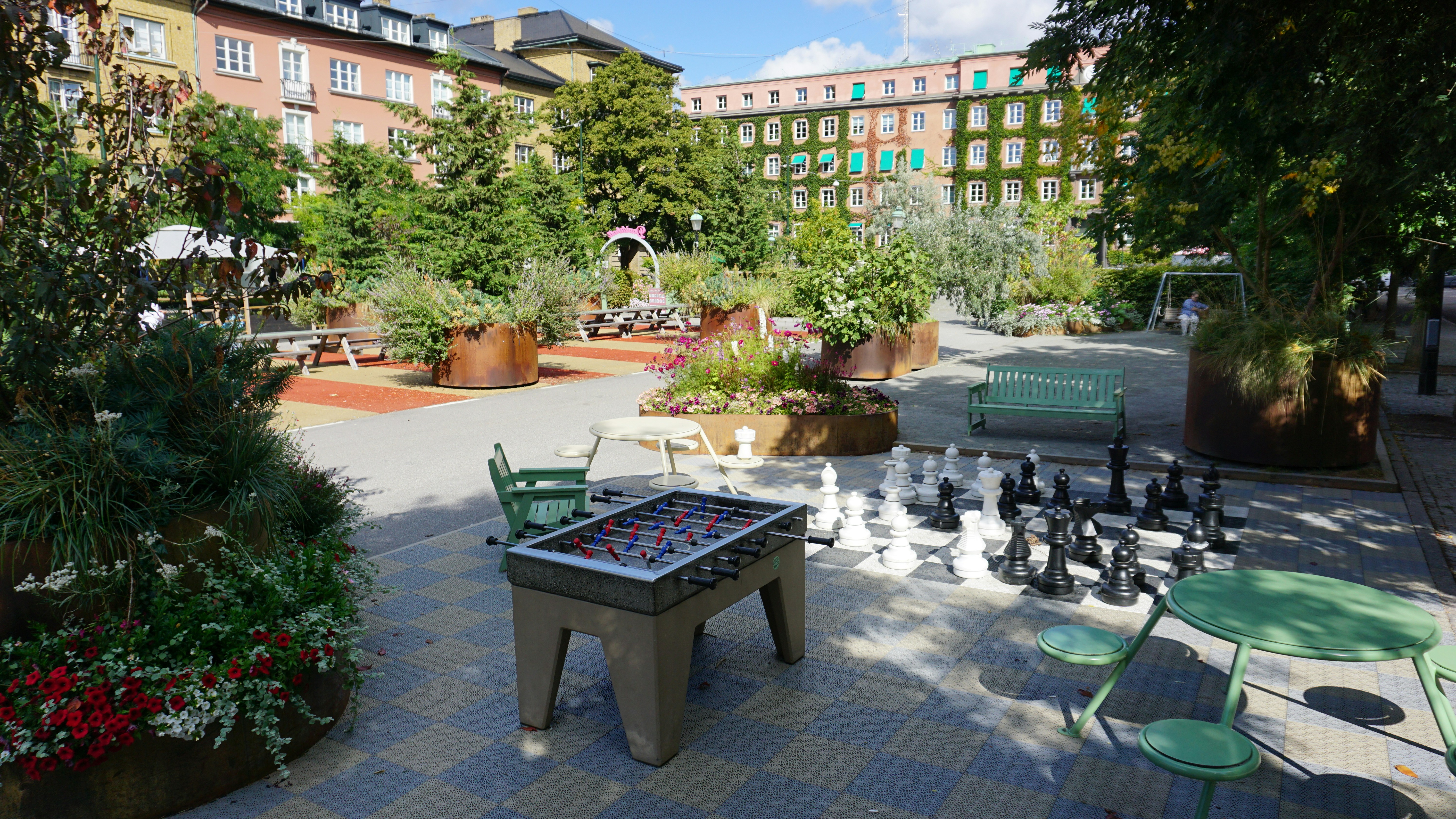 Sunlit Plaza: A Chessboard Oasis Amid Urban Bloom