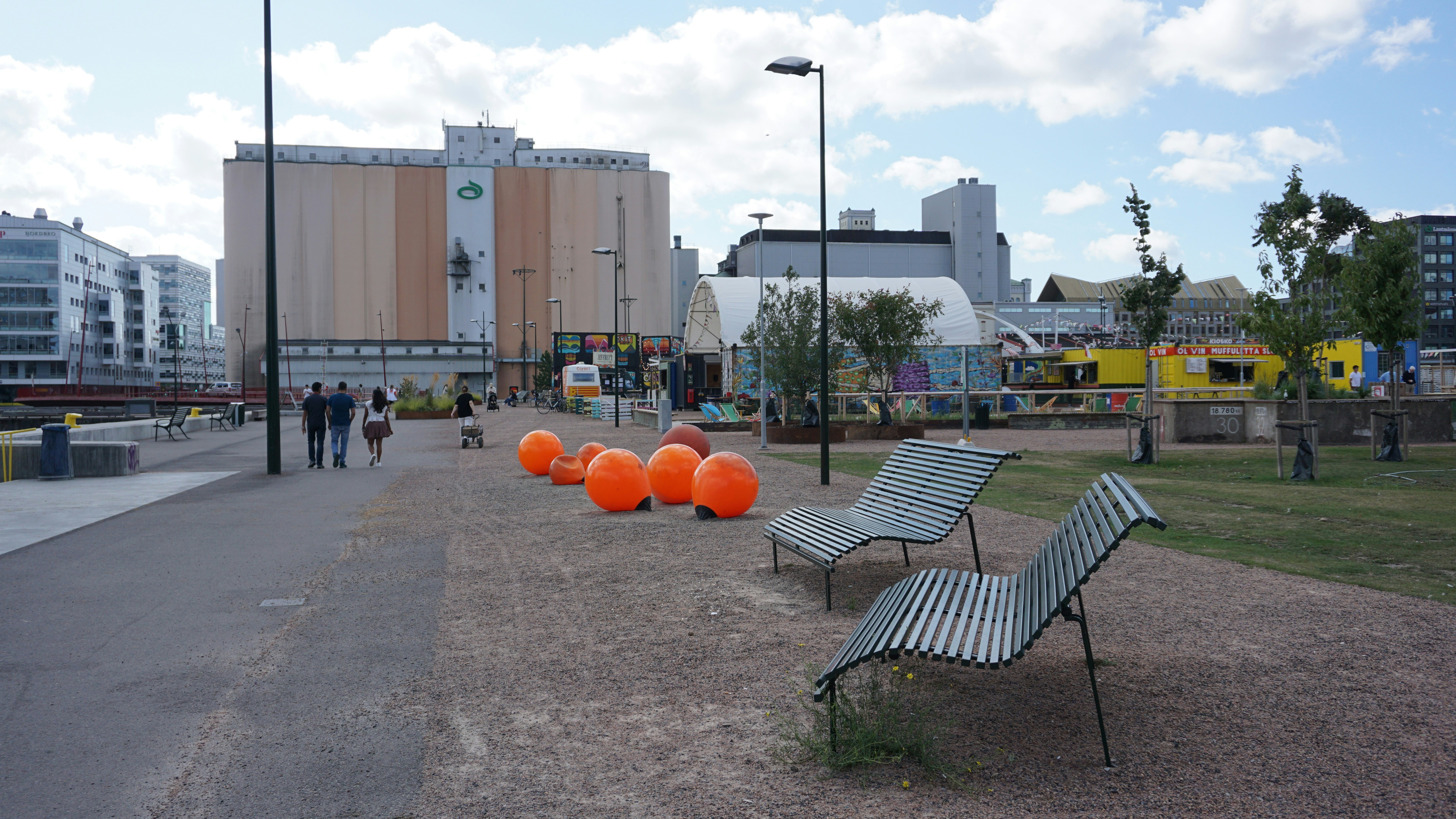 Orange Spheres on a Coastal Plaza: Urban Light and People in Motion