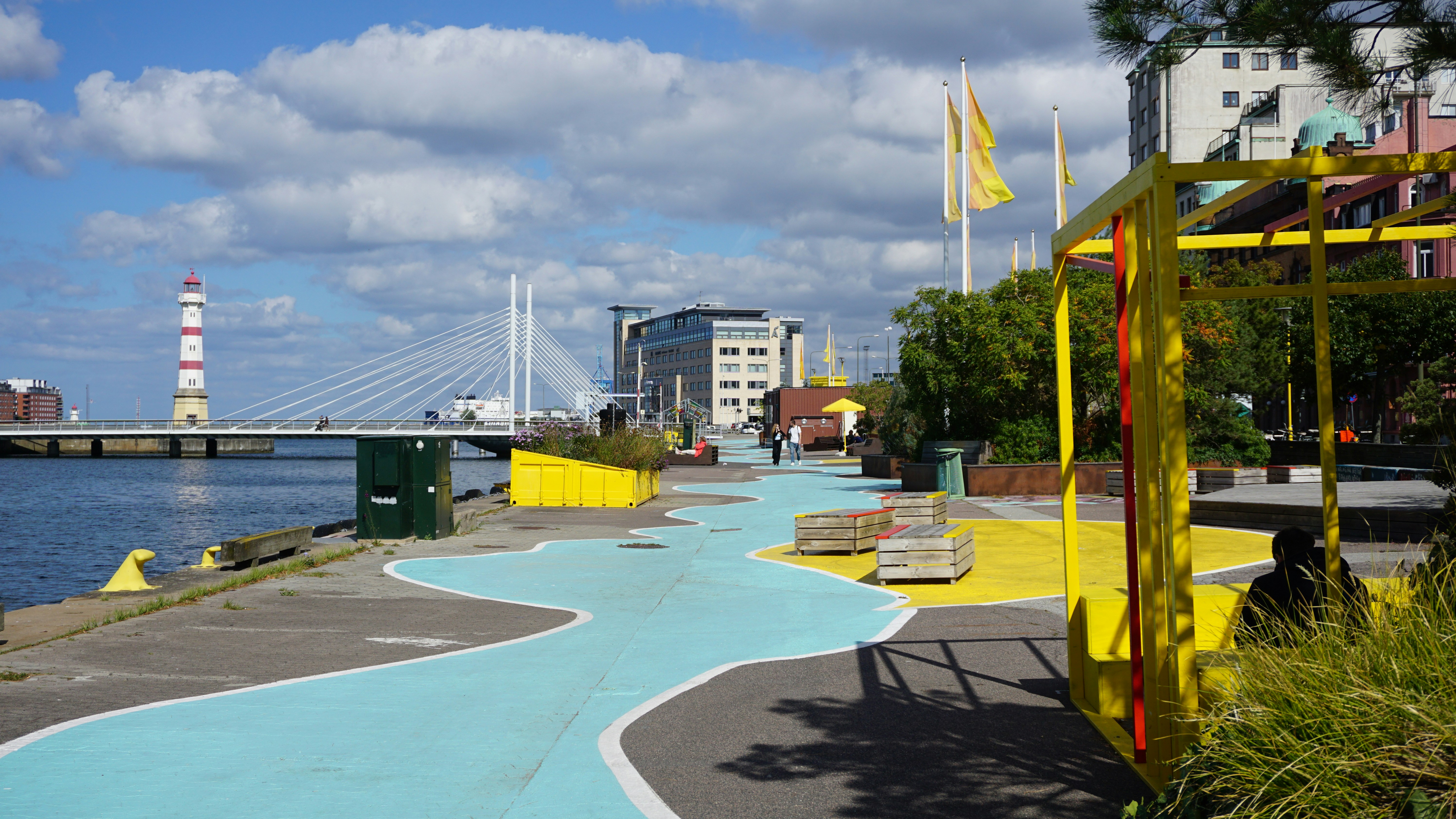 Colorful Seaside Walkway Beneath a Bright Sky