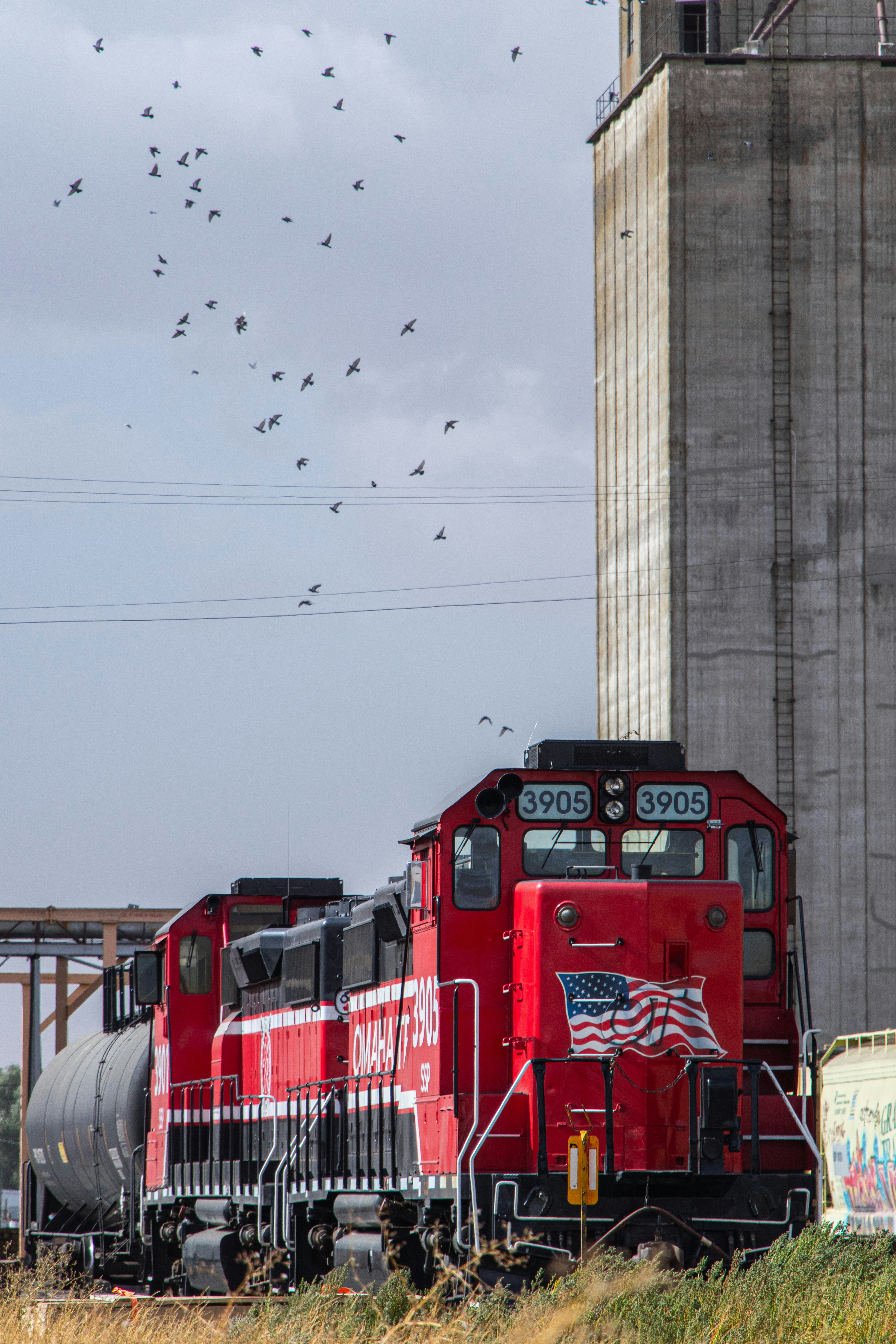 Red Locomotive at the Edge of an Industrial Silhouette