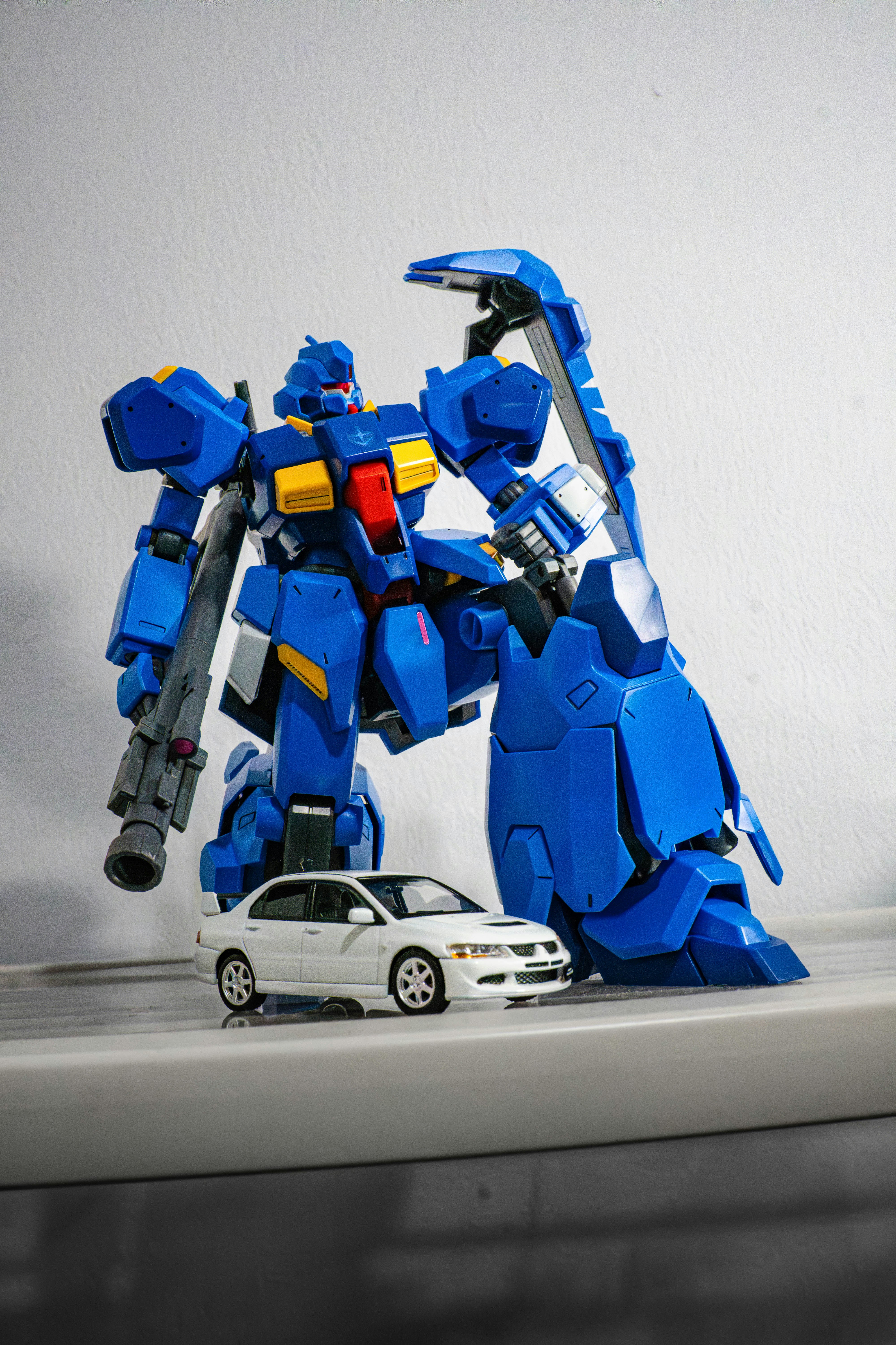 Blue Colossus and Sedan: A Toy-Scale Showdown