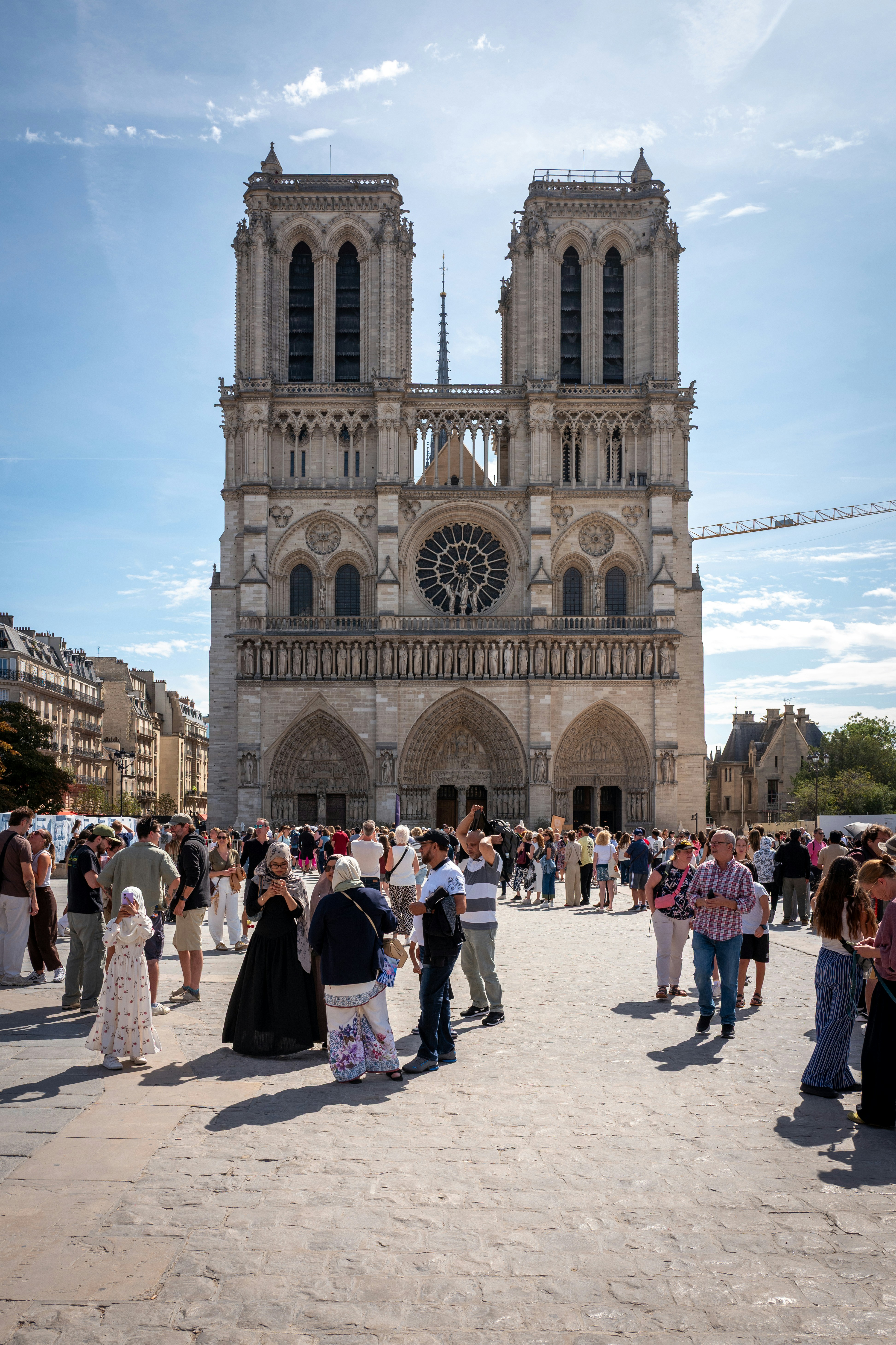 Crowd at Notre-Dame Cathedral Under Clear Sky