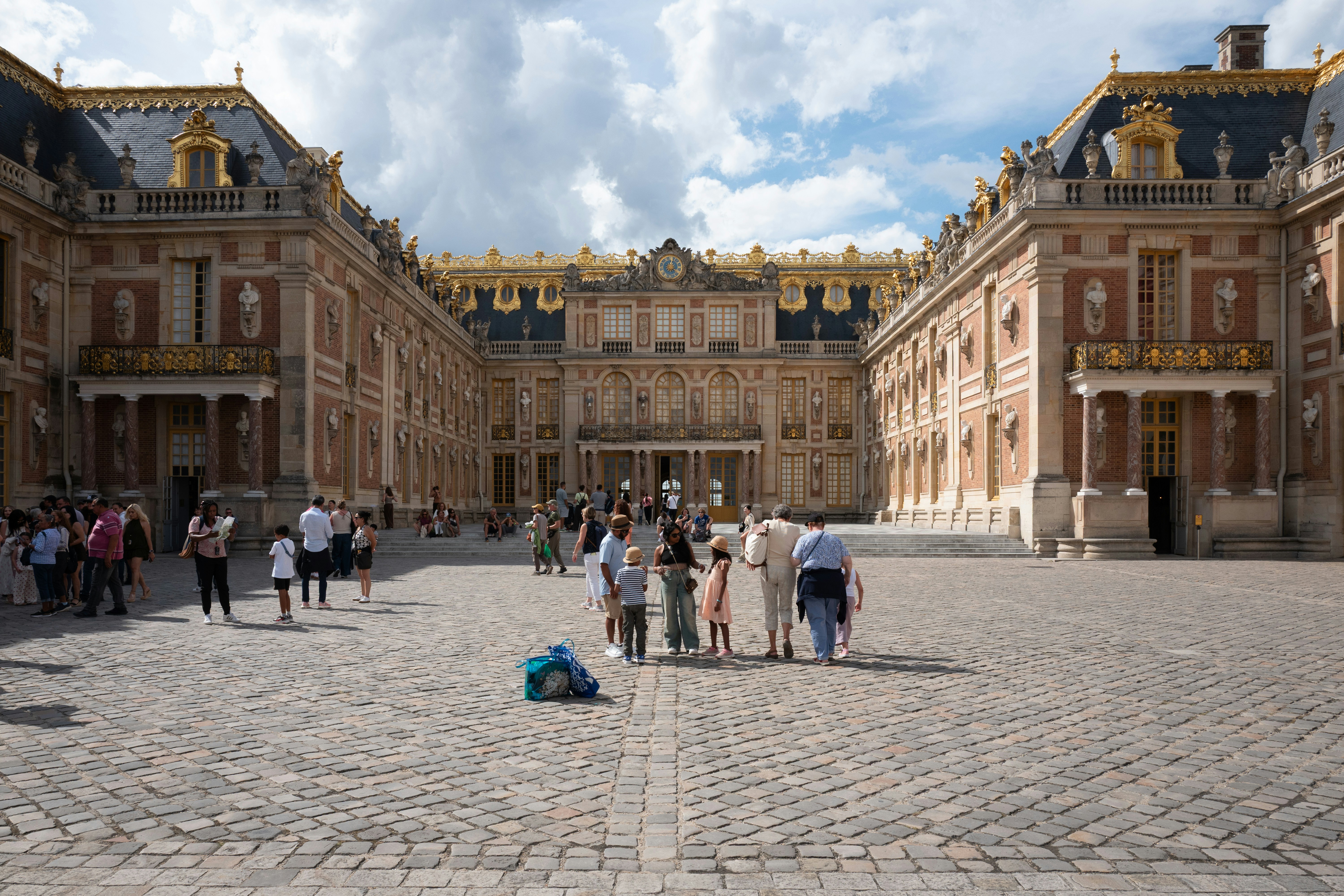 Quiet Plaza at the Louvre: Tourists Gather Before the Grand Facade