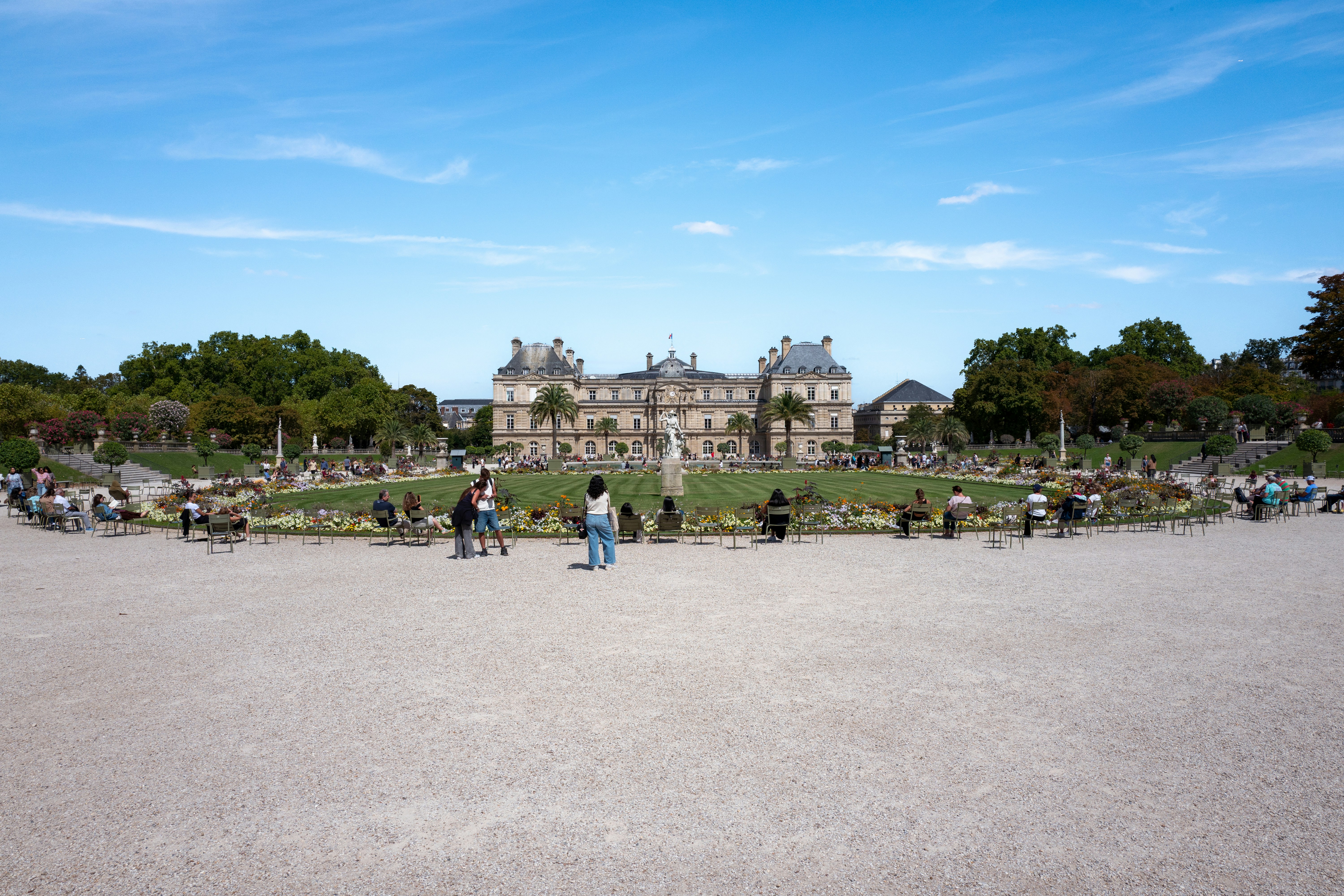 People at the Tuileries with the Louvre in the distance