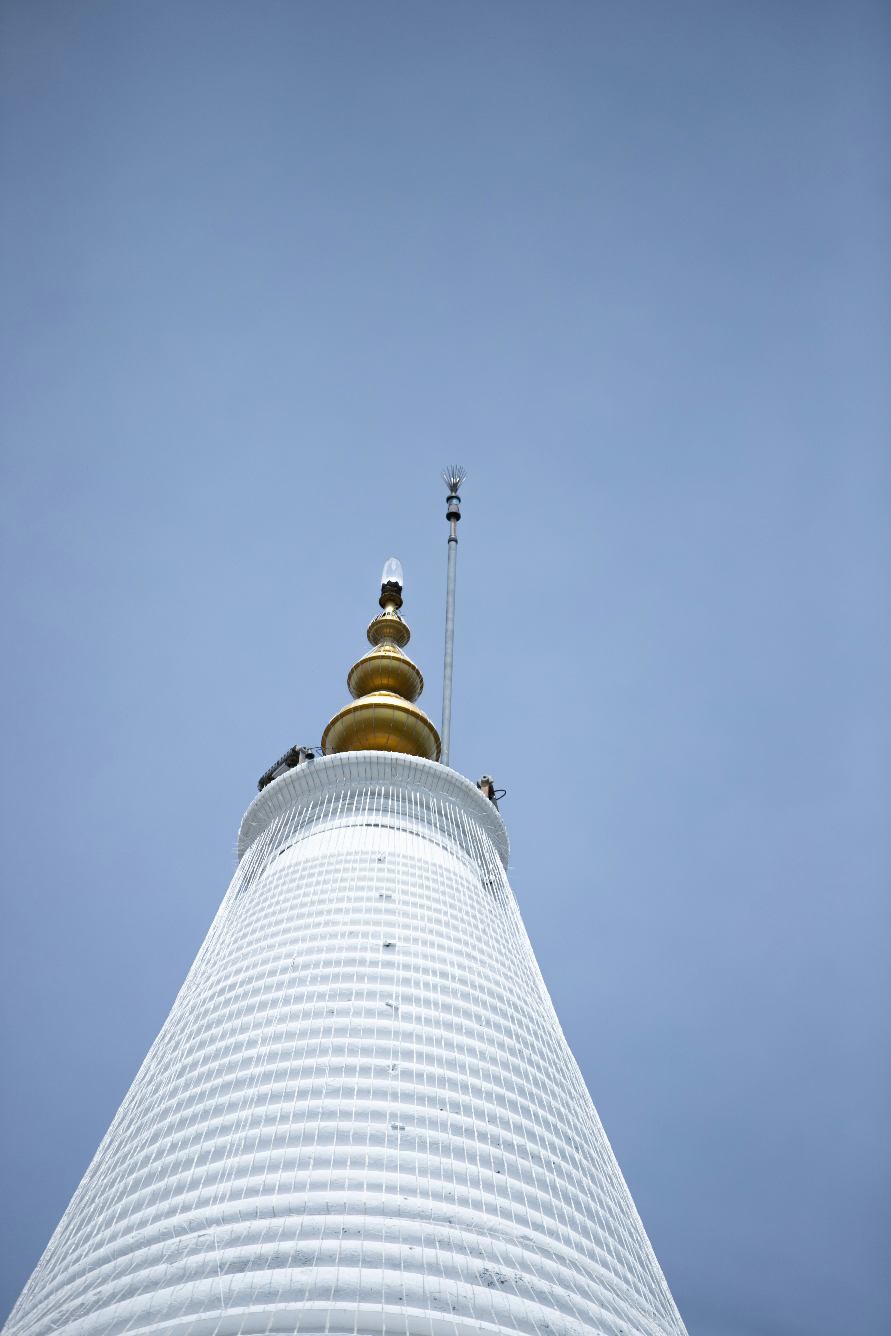 Spire Ascending: A White Needle Reaching Skyward
