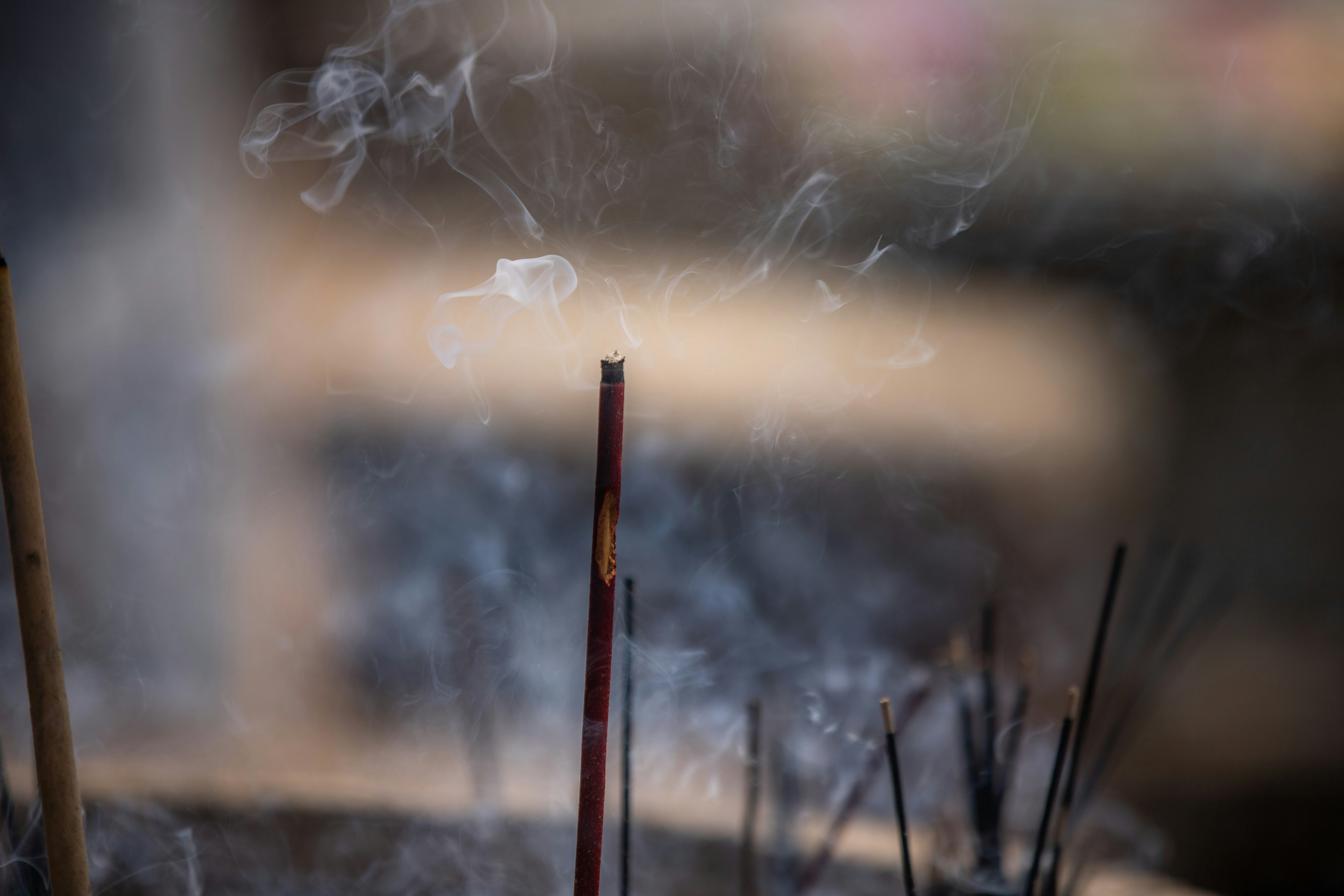 Whispering Ember: A single incense stick with curling smoke