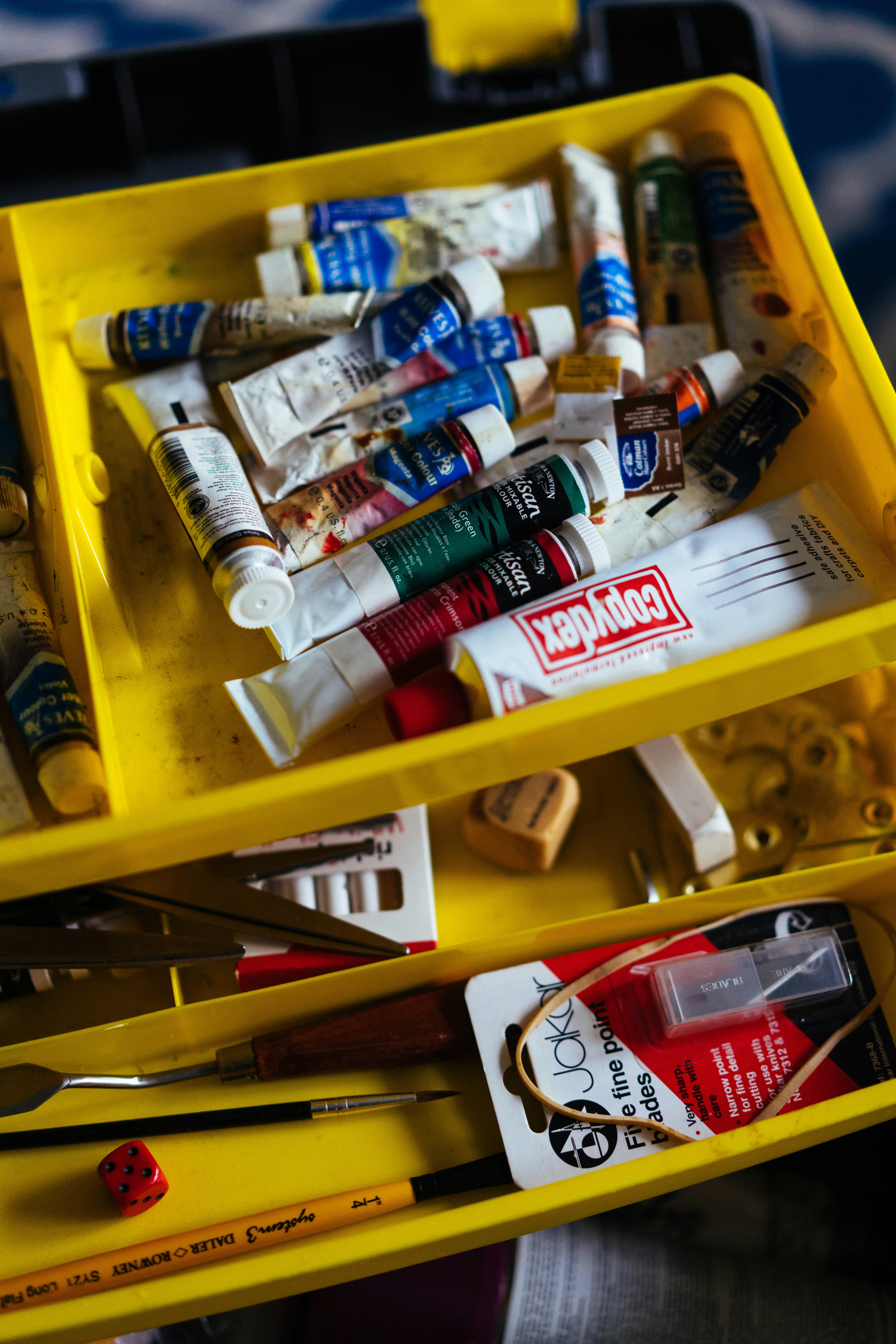 Palette of Paints and Tools in a Bright Yellow Organizer