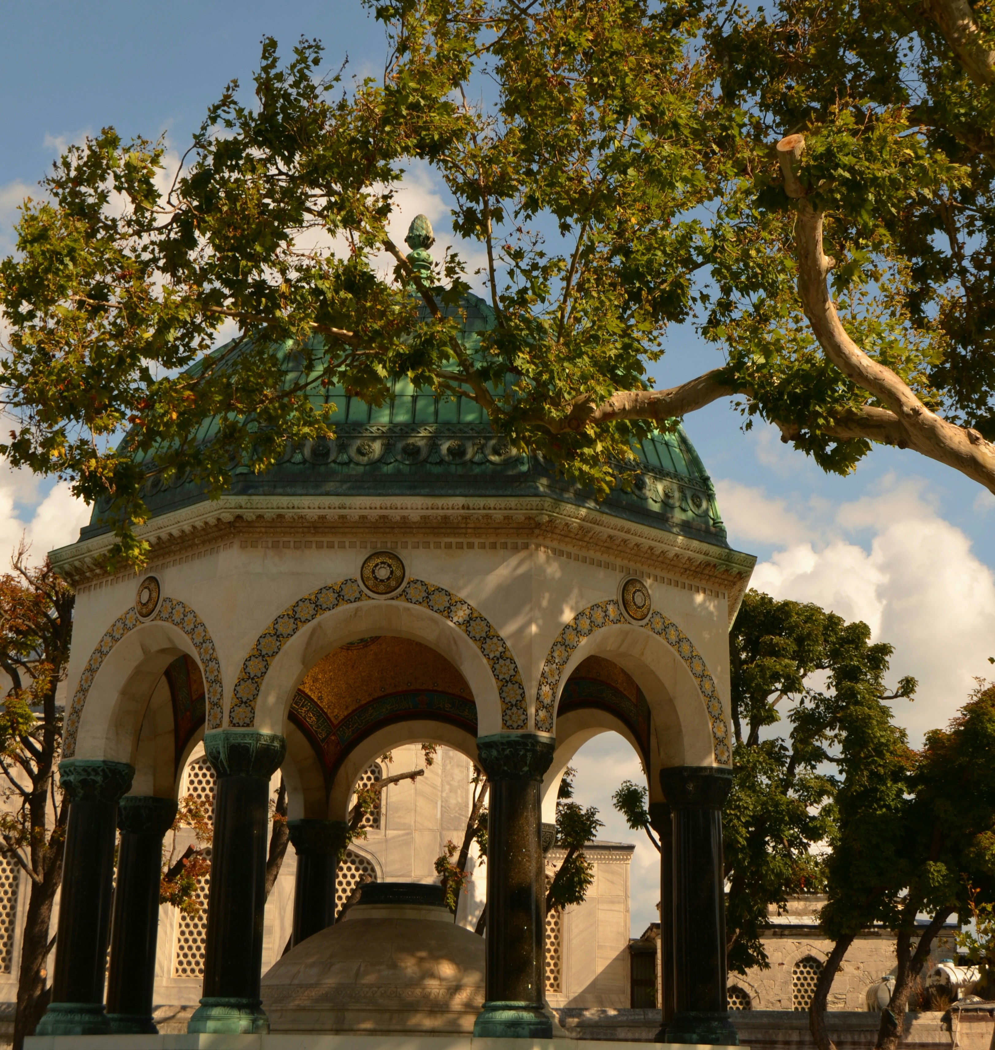 Arched Pavilion Framed by Tree Canopy in Warm Sun