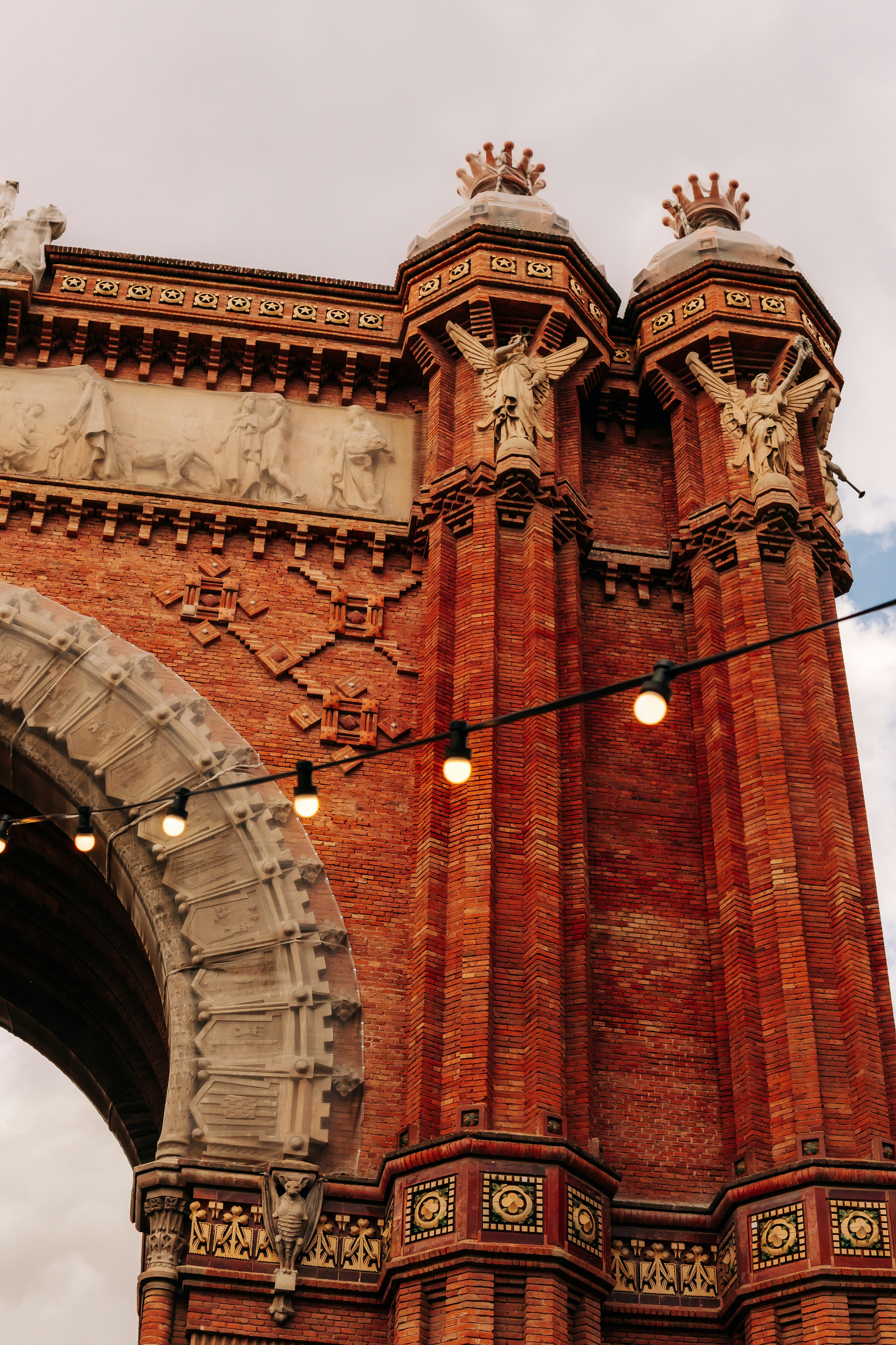 Brick Archways and Topped Turrets: A Night of Warm Lights on a Historic Gateway