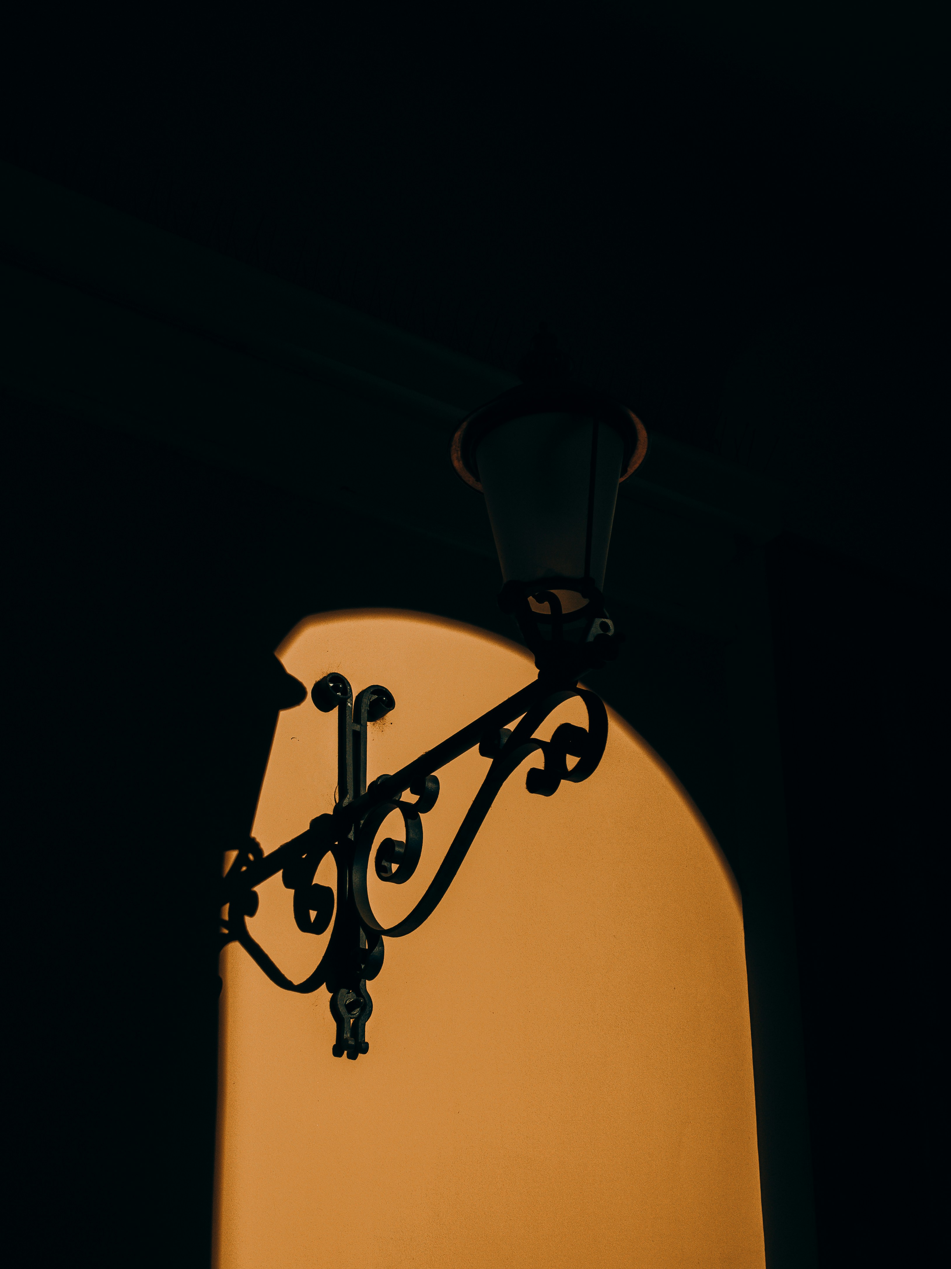 Warm Glow: A Street Lamp Archway in Night Shadow