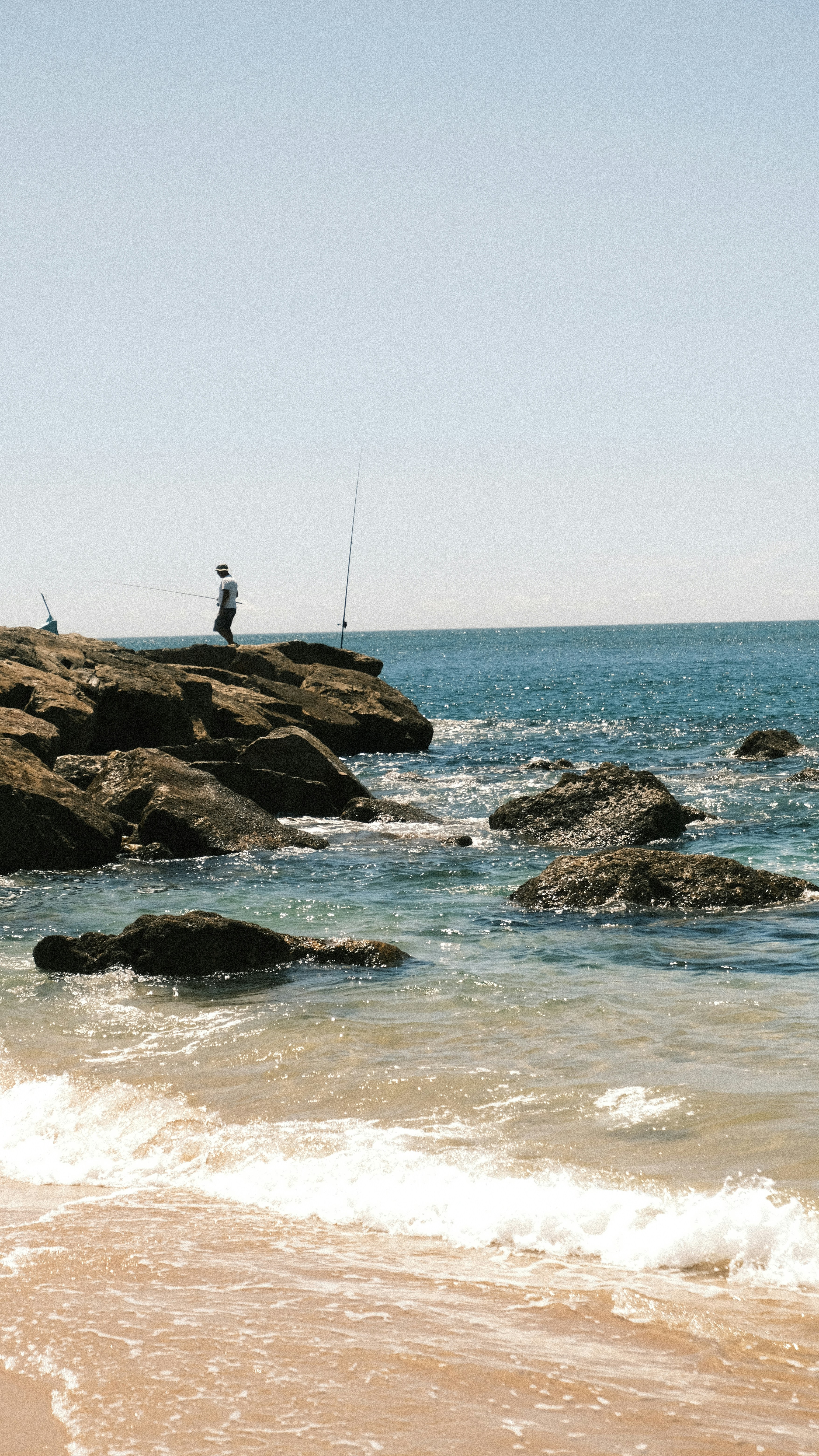 Rugged Waterfront Moment: Fisherman on the Break with Tackle in Tow