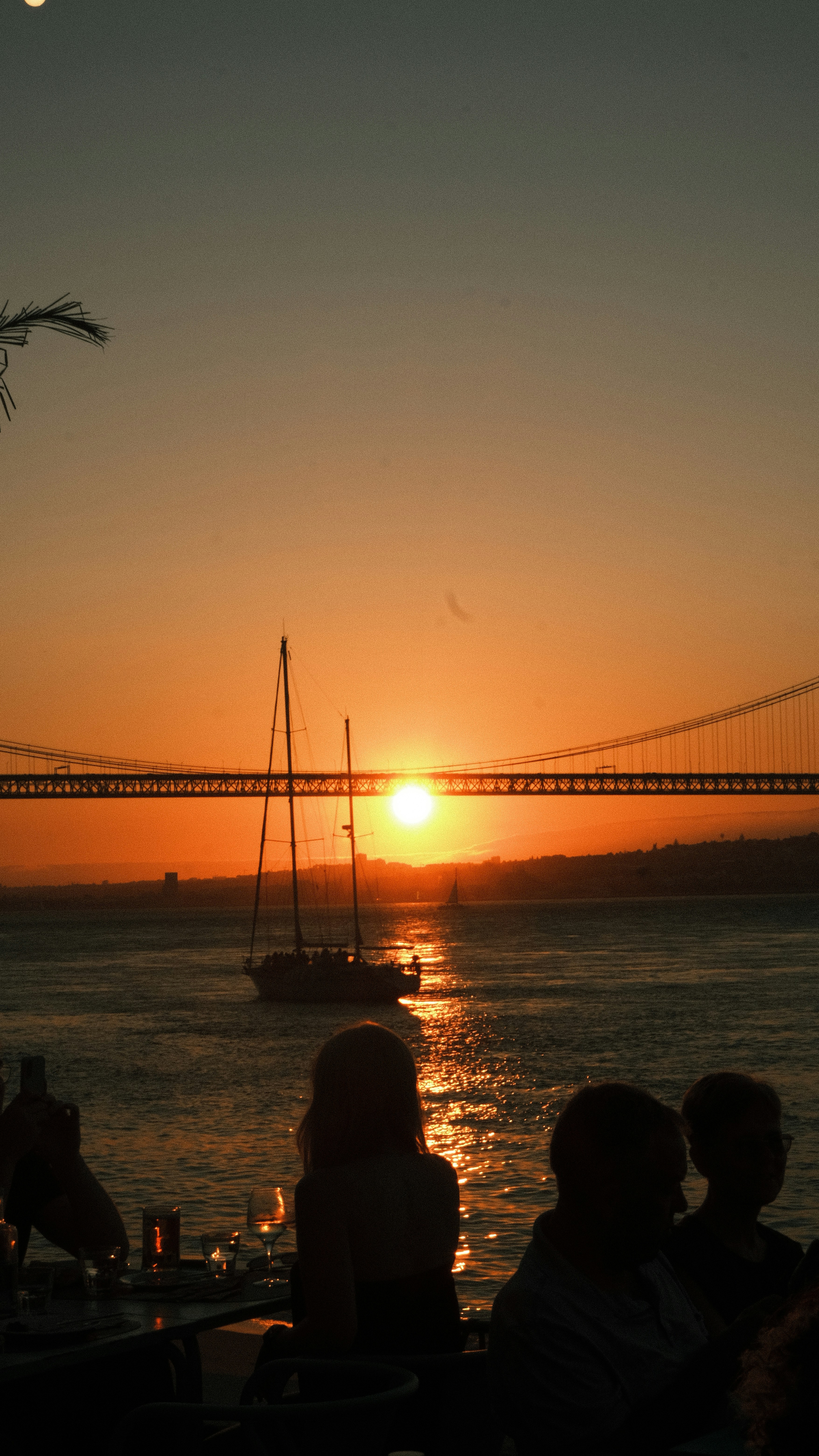 Sunset Over the Sailboat: silhouettes at the waterfront cafe