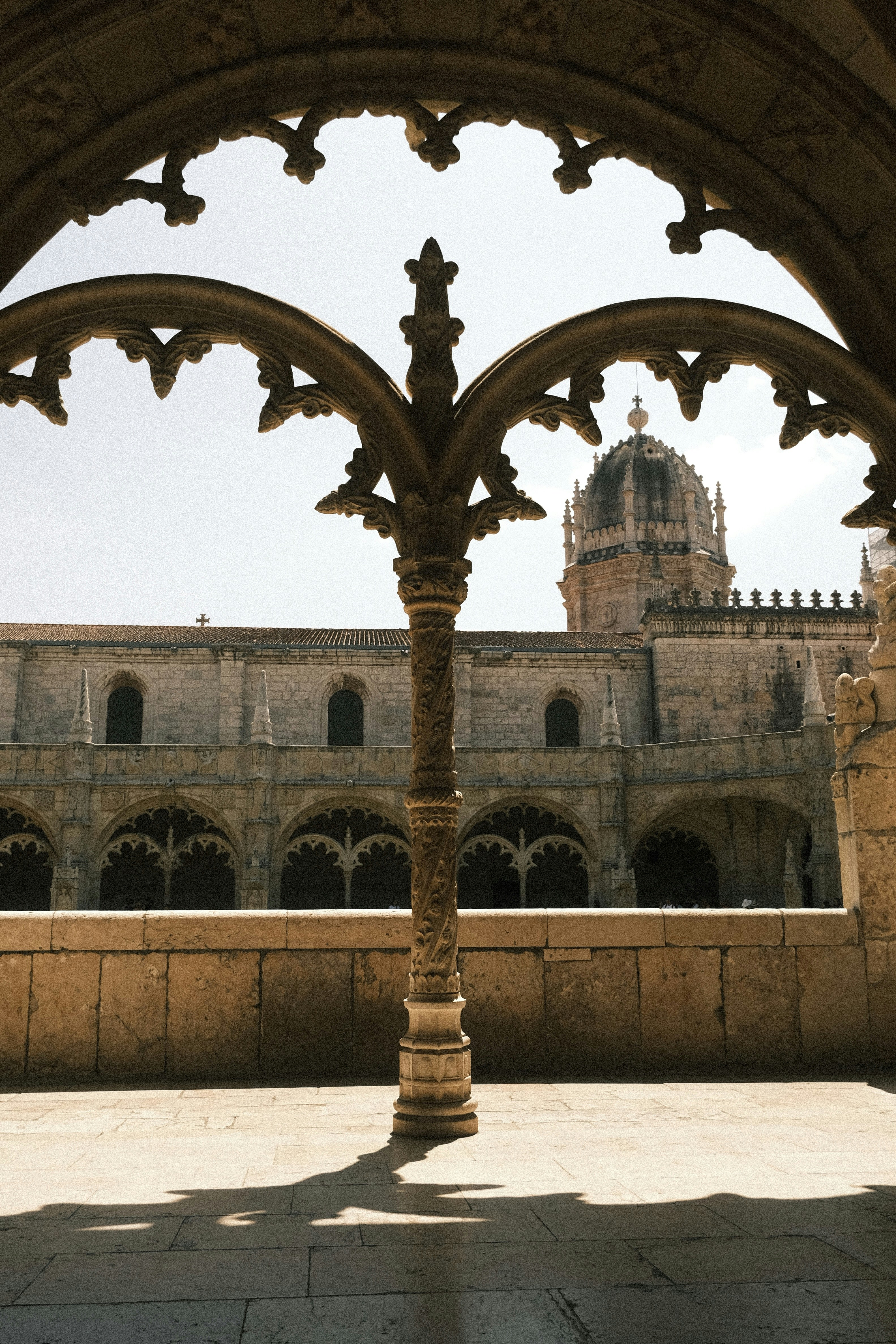 Stone Arc Framing a Sunlit Cloister Garden