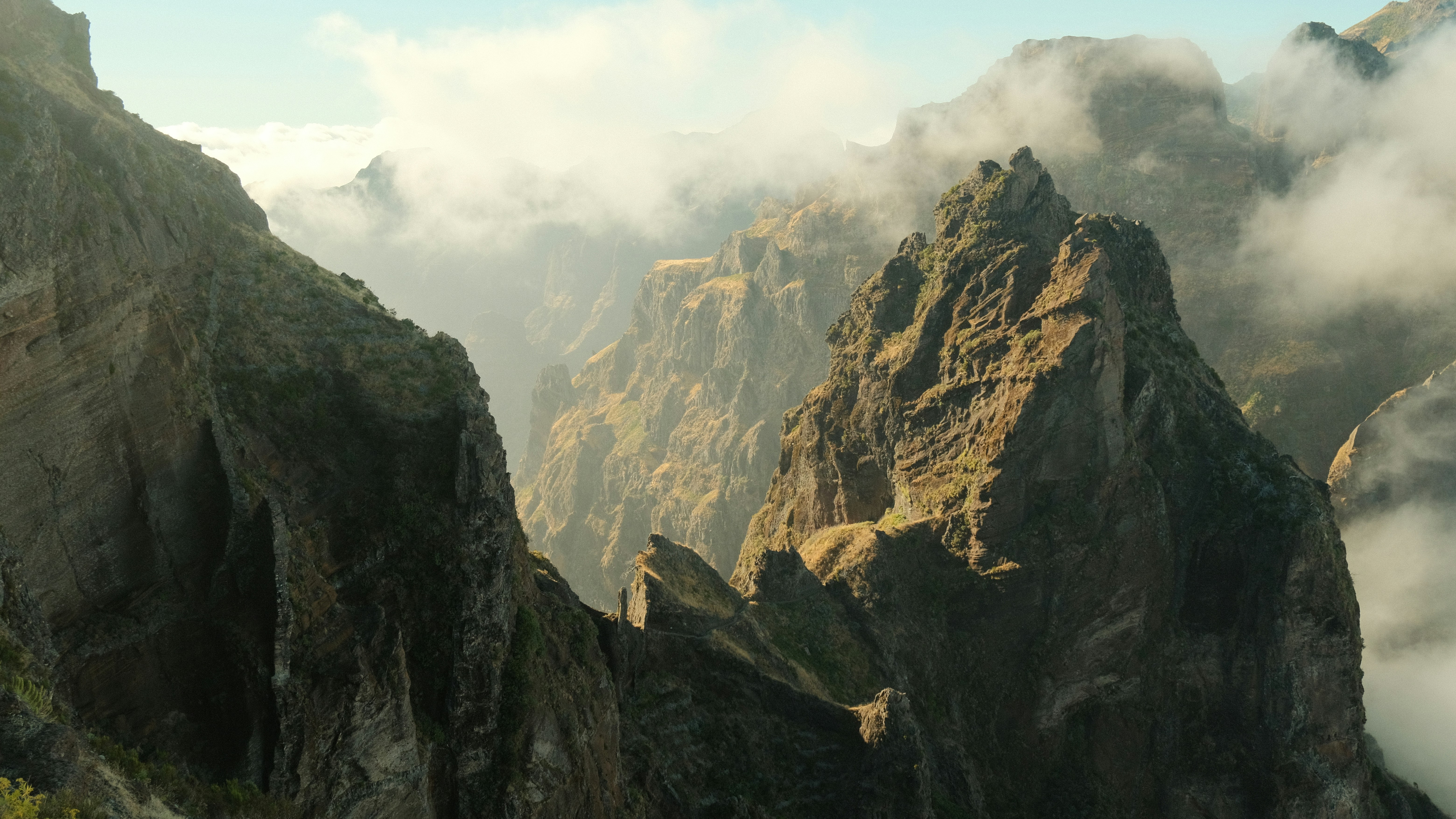 Cloud-sculpted Peaks Amidst Dawn Mist