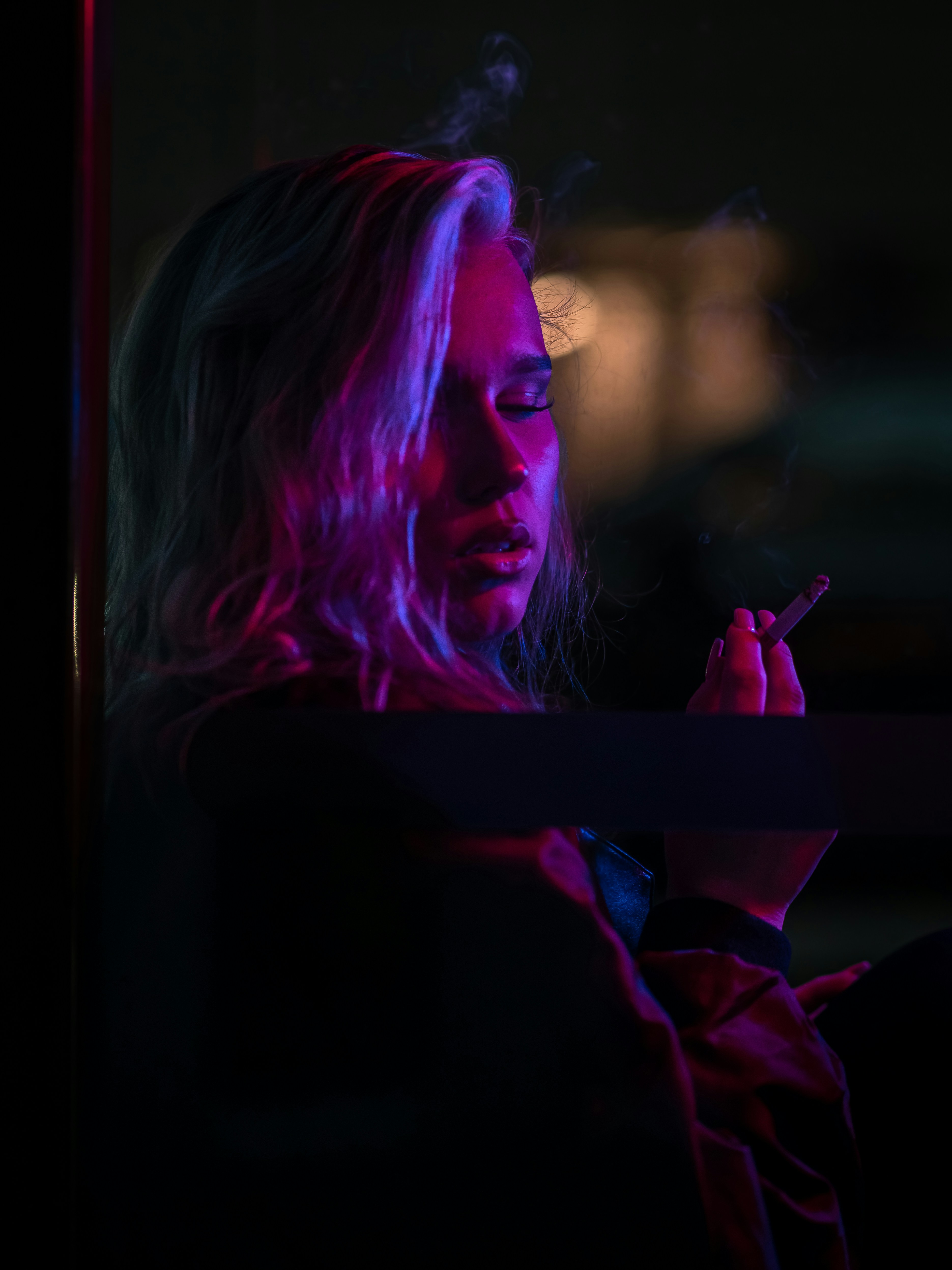 Neon Haze: A Veiled Moment at the Smoking Window