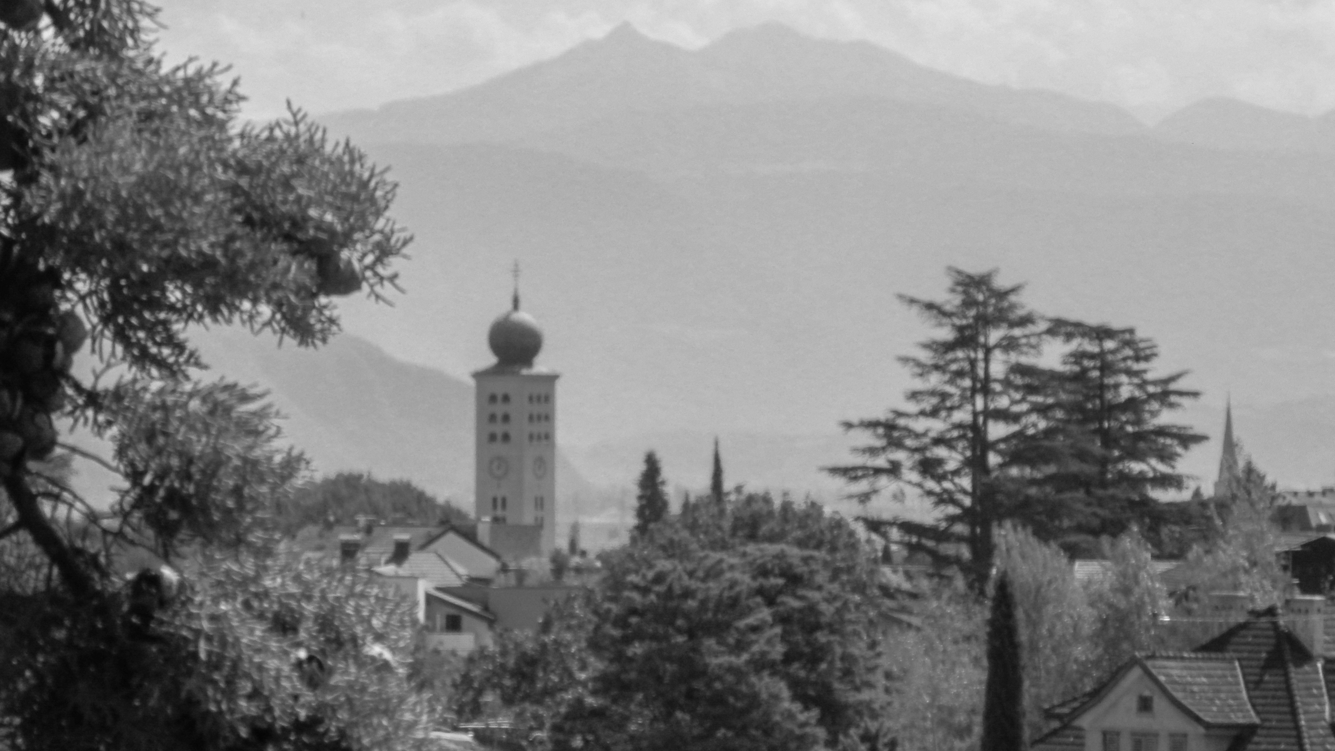 Silhouetted Minarets Amid Hilltop Village
