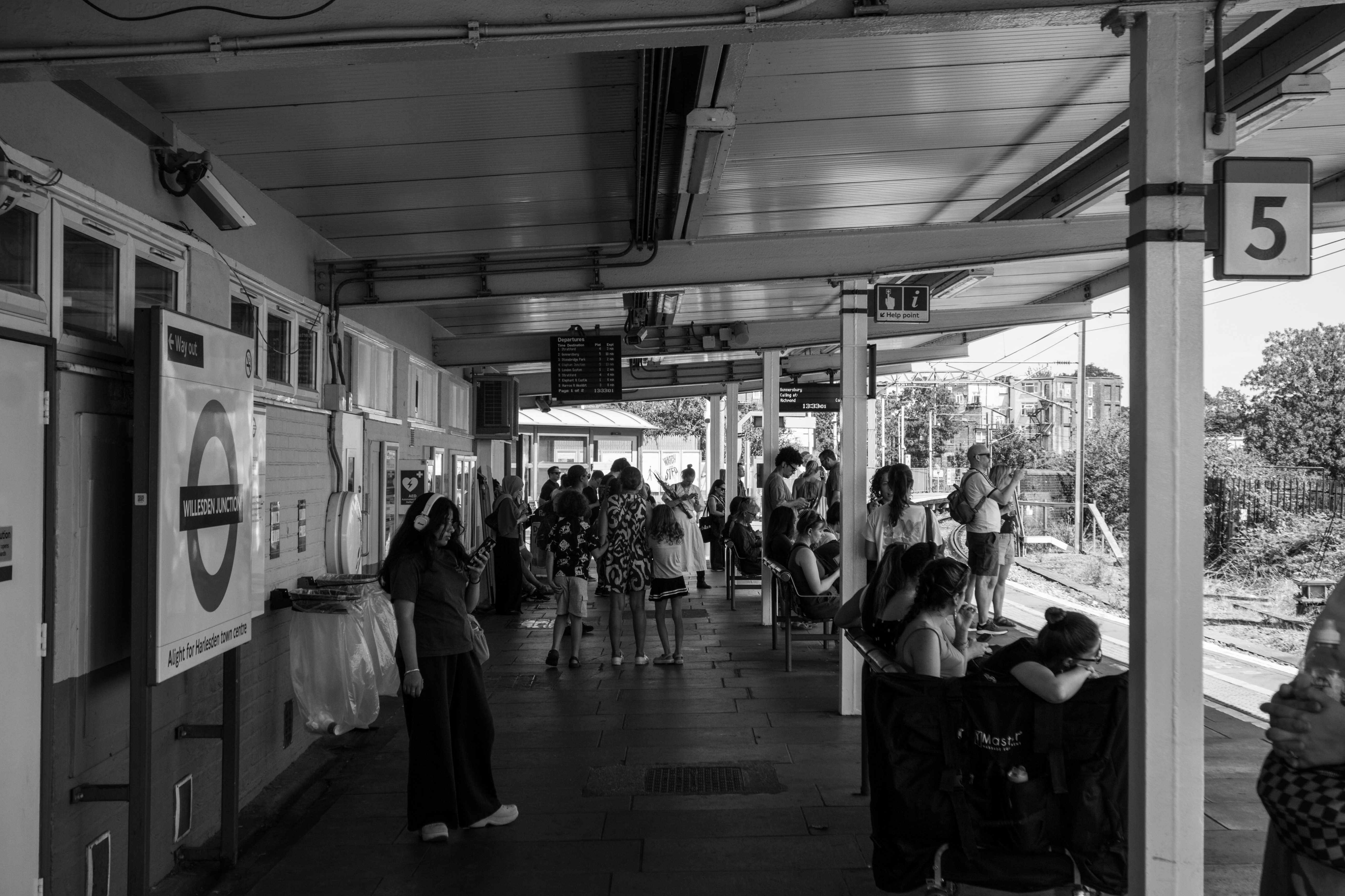 Platform Pause: Quiet Faces in a Busy Transit Seat Row