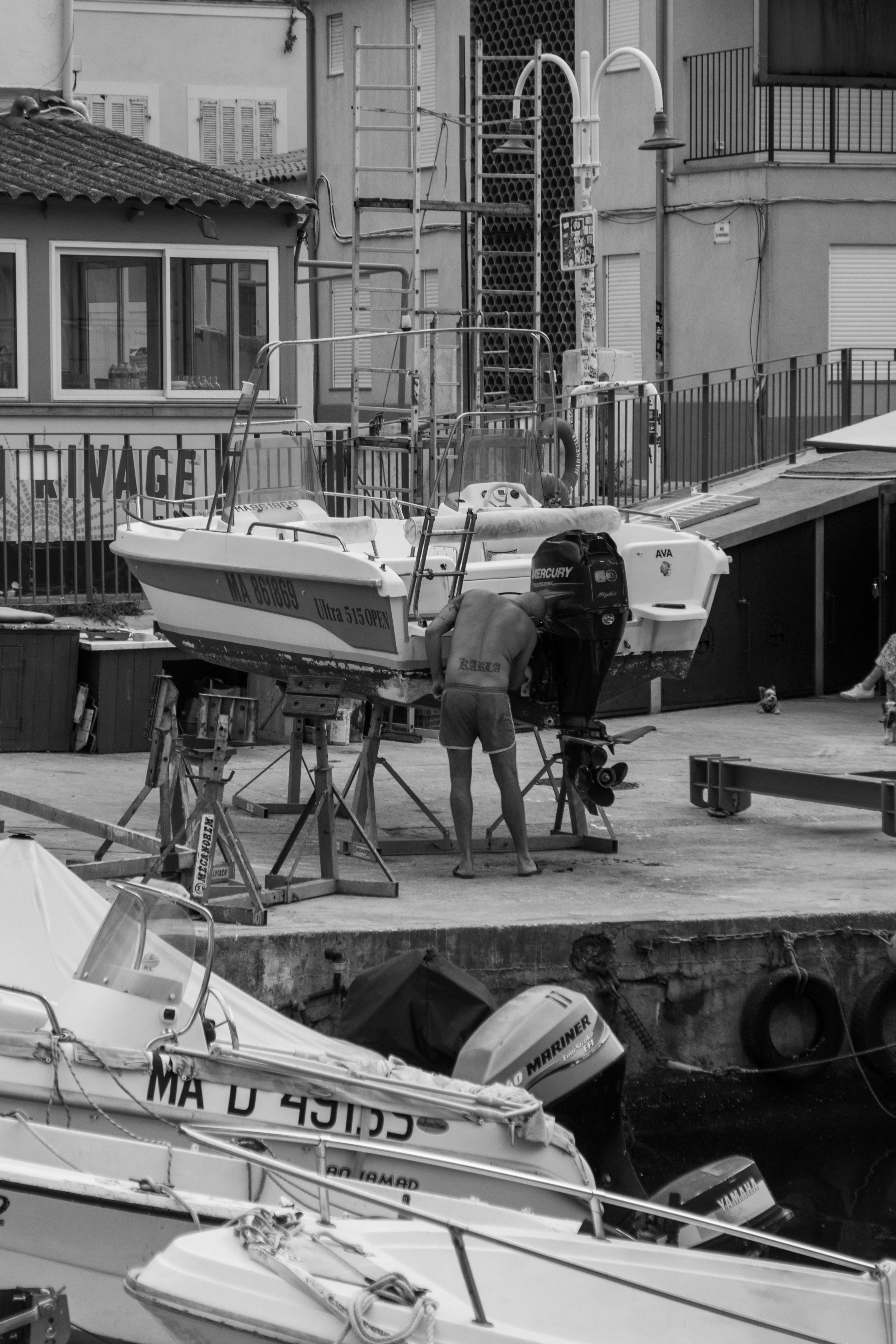Harbor Workshop: Man and Motor at the Boat Lift