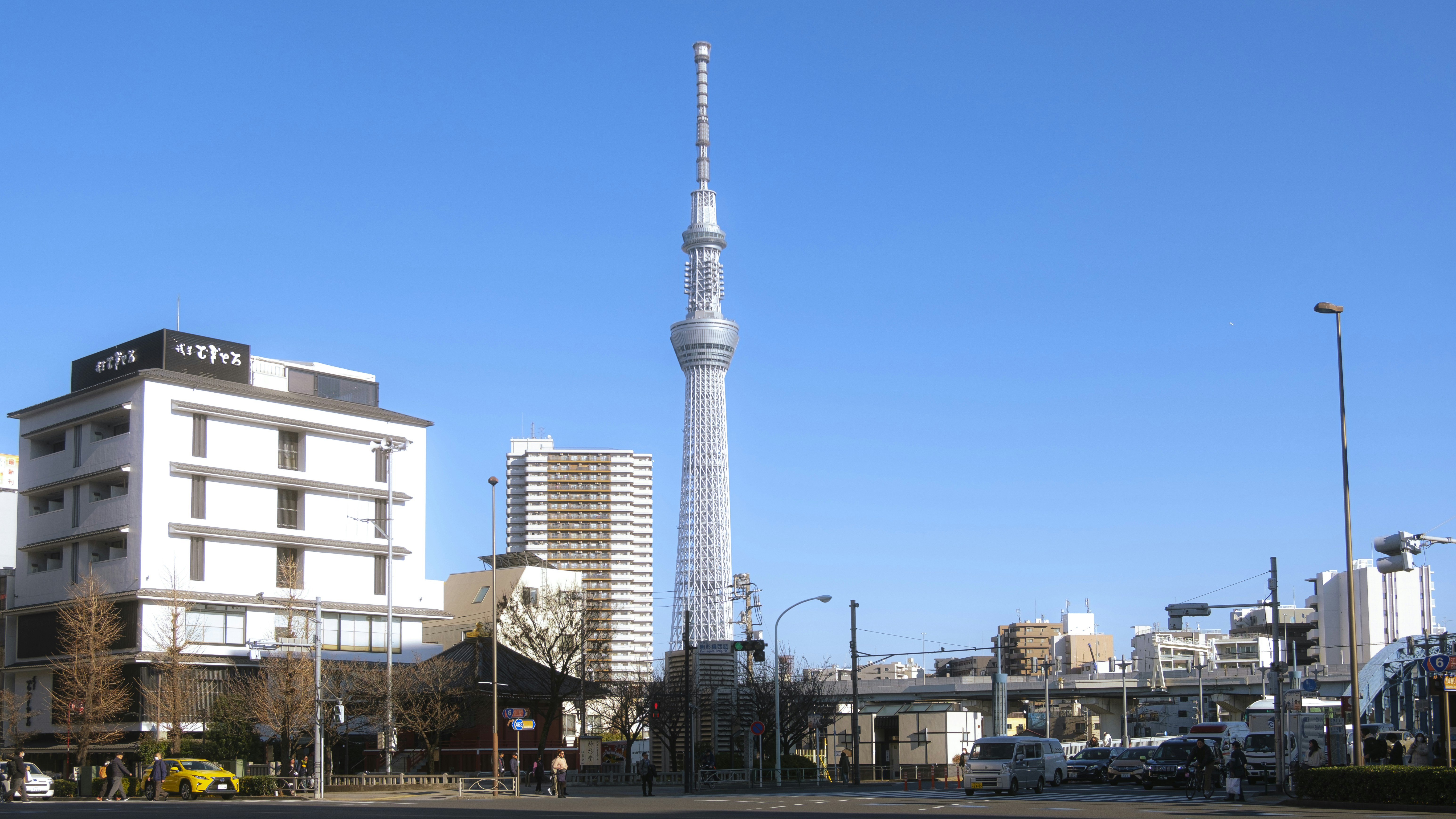 Tokyo Skyscraper Portrait: The City Tower Framed by Street-Level Activity