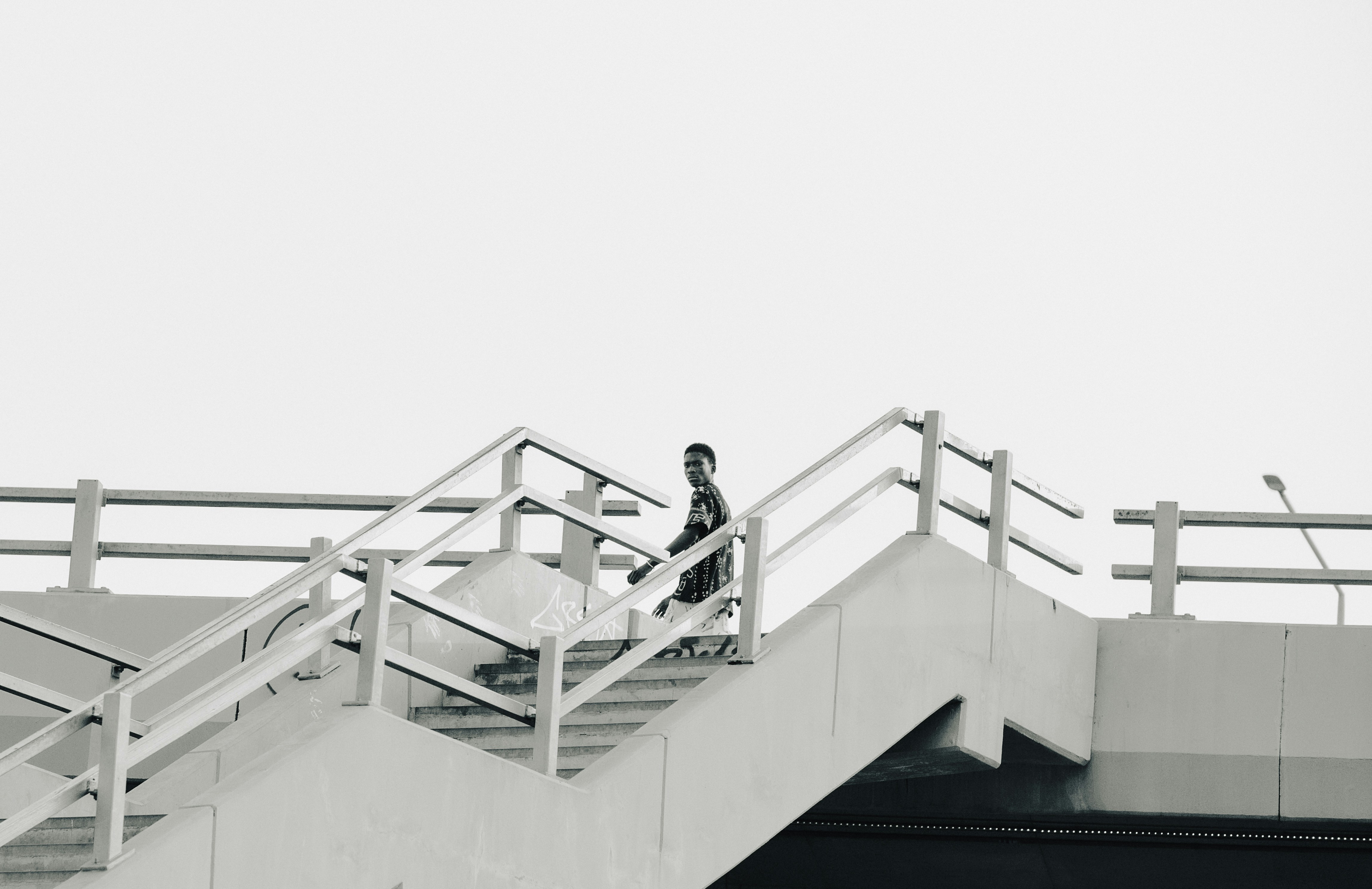 Staircase Convergence: A Lone Figure Amid Abstract Geometry