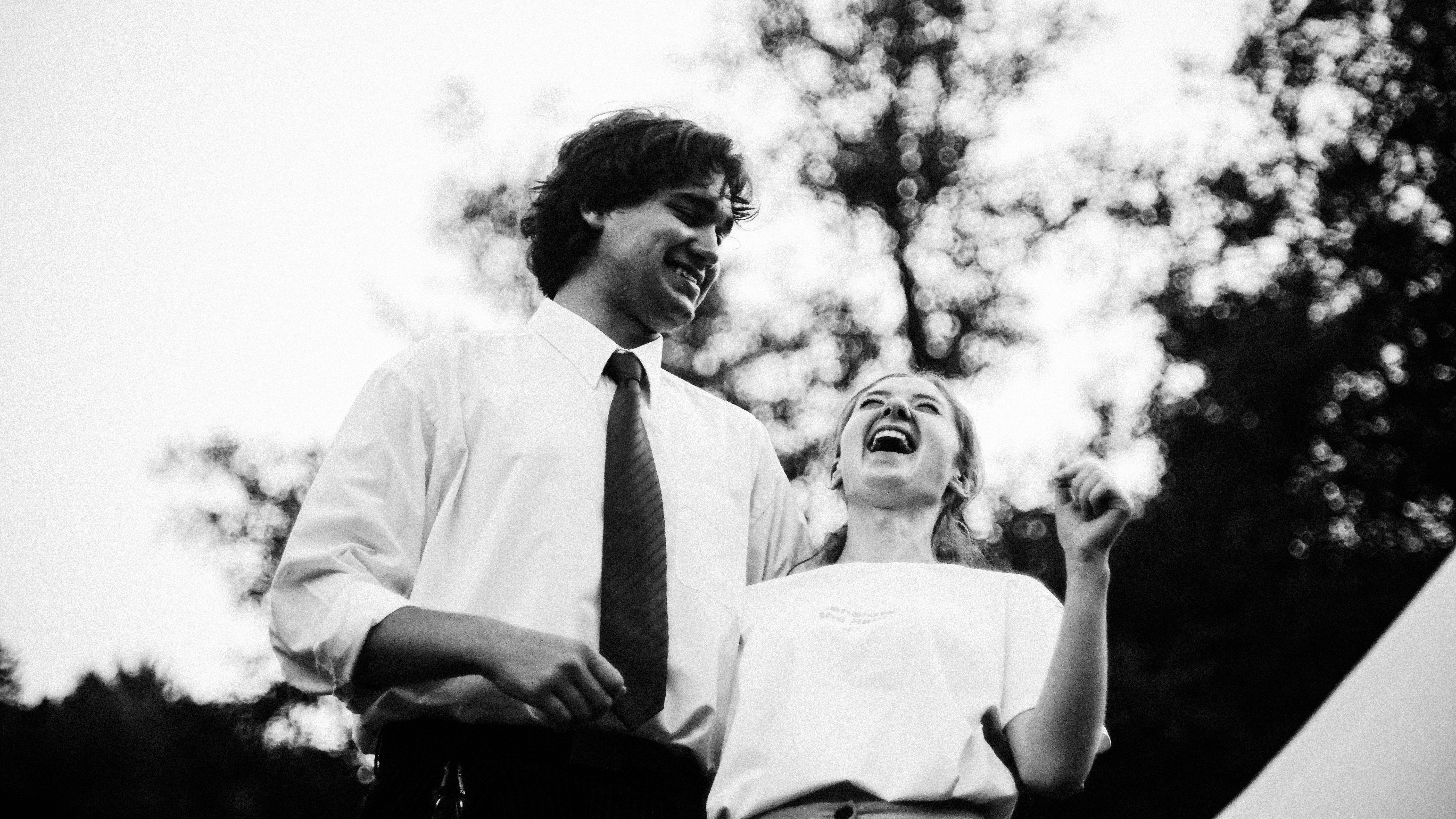 Joyful Toast: Two Friends Laughing Under Open Skies