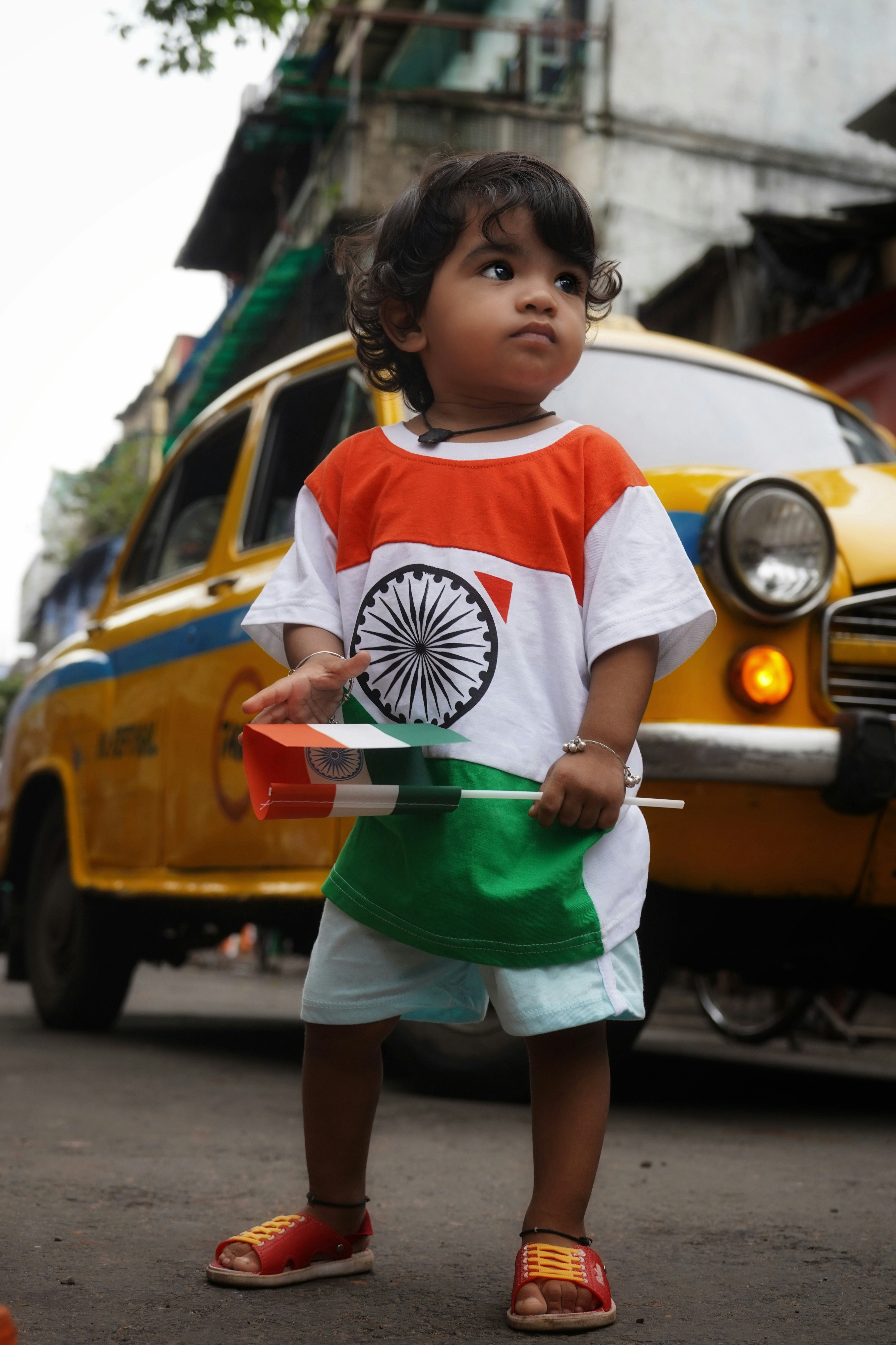 Little Flagbearer Amid the Taxi tide