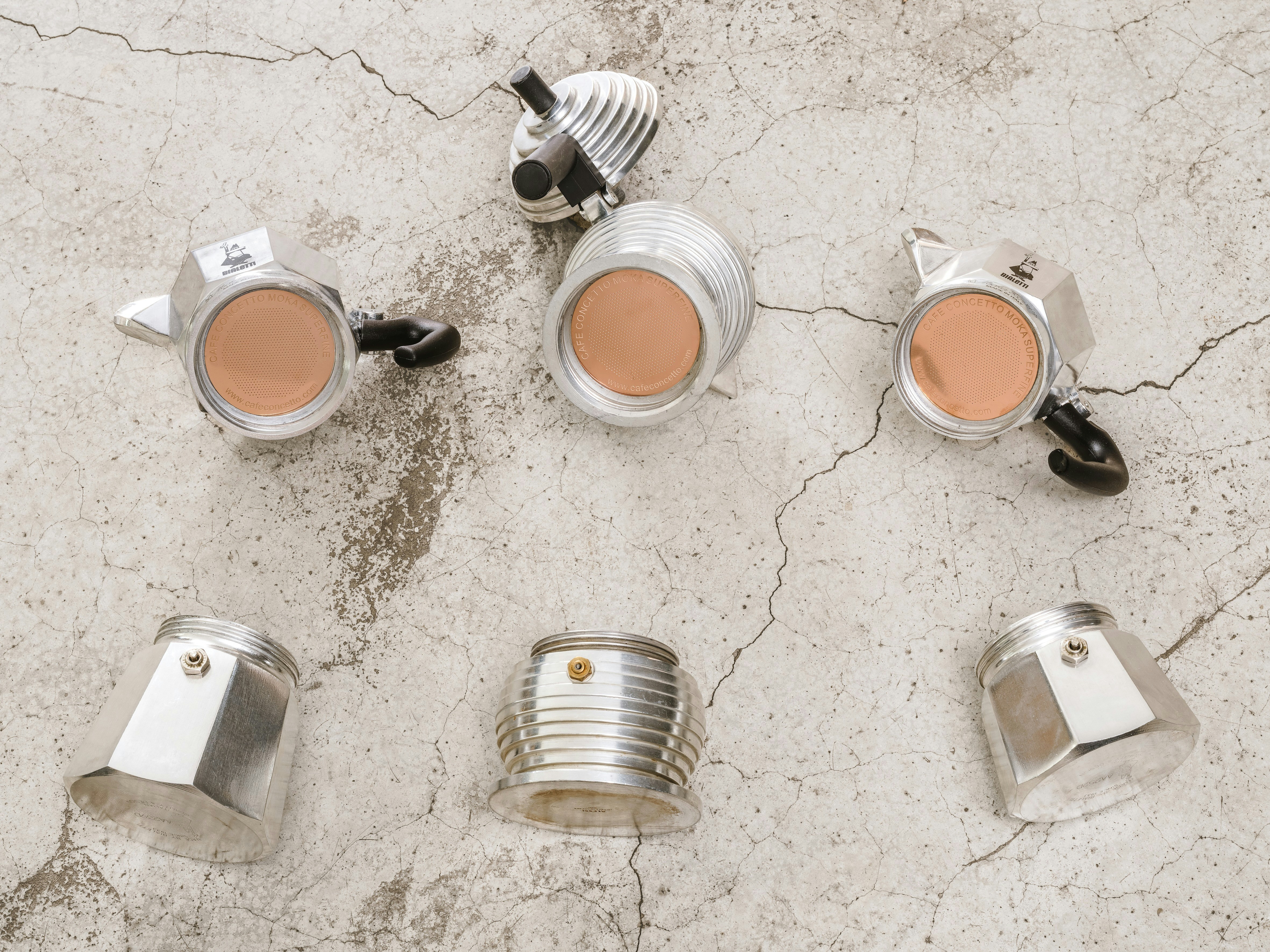 Copper-Capped Lids on a Weathered Concrete Surface