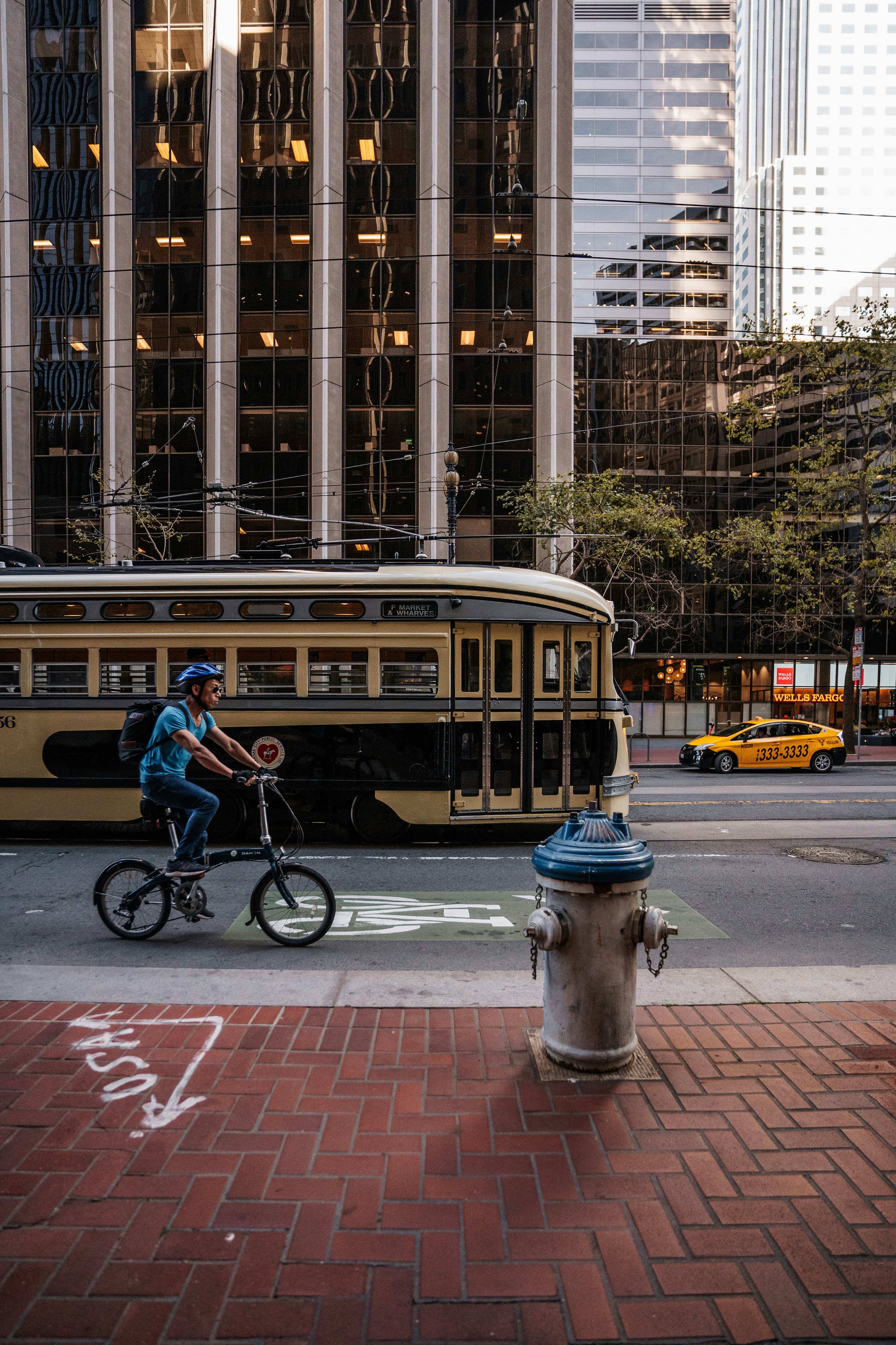 Urban Pulse: A Cyclist Crossing Paths with a Streetcar