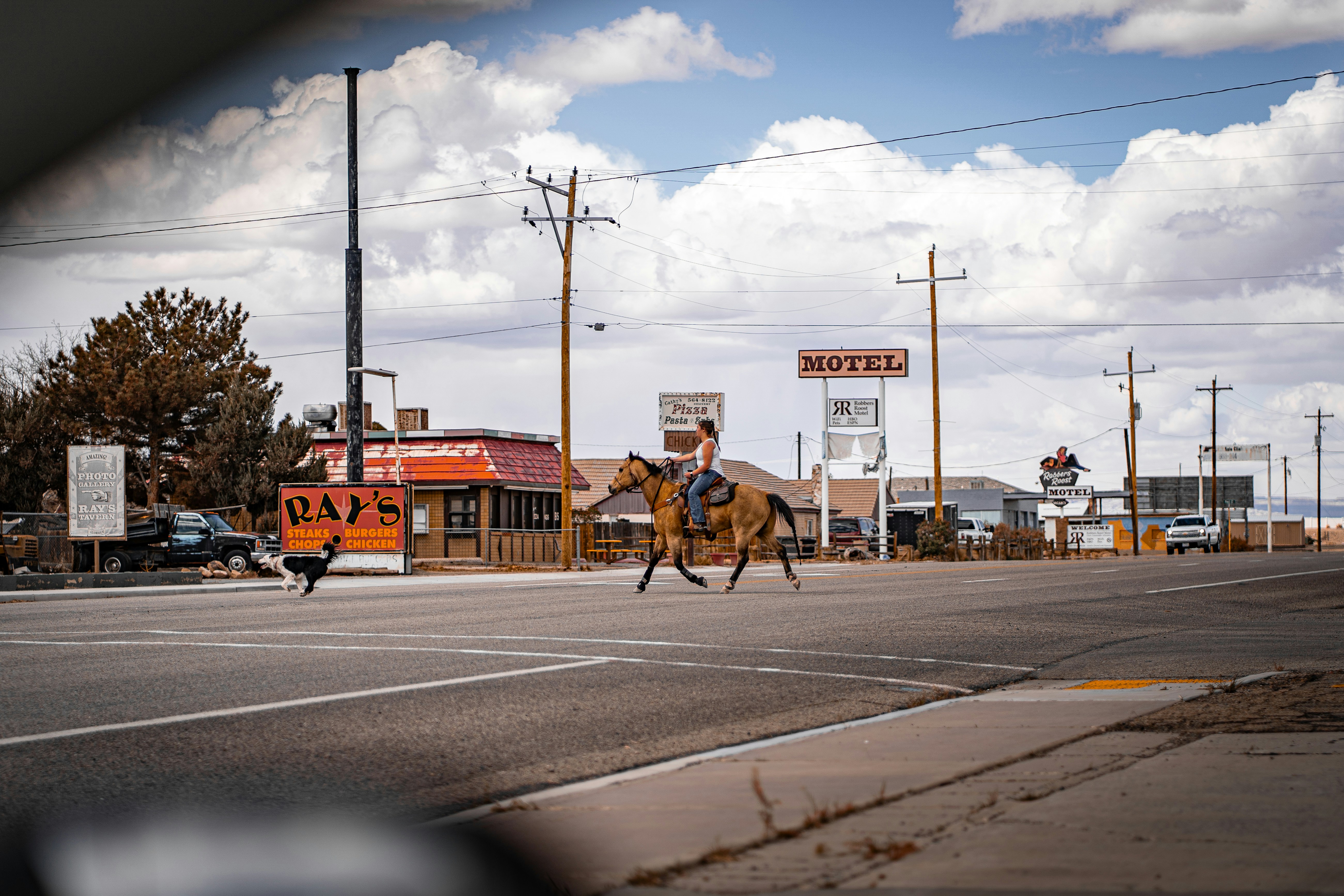 Dusty Main Street: Horseback Rider Crossing Daytime Highway