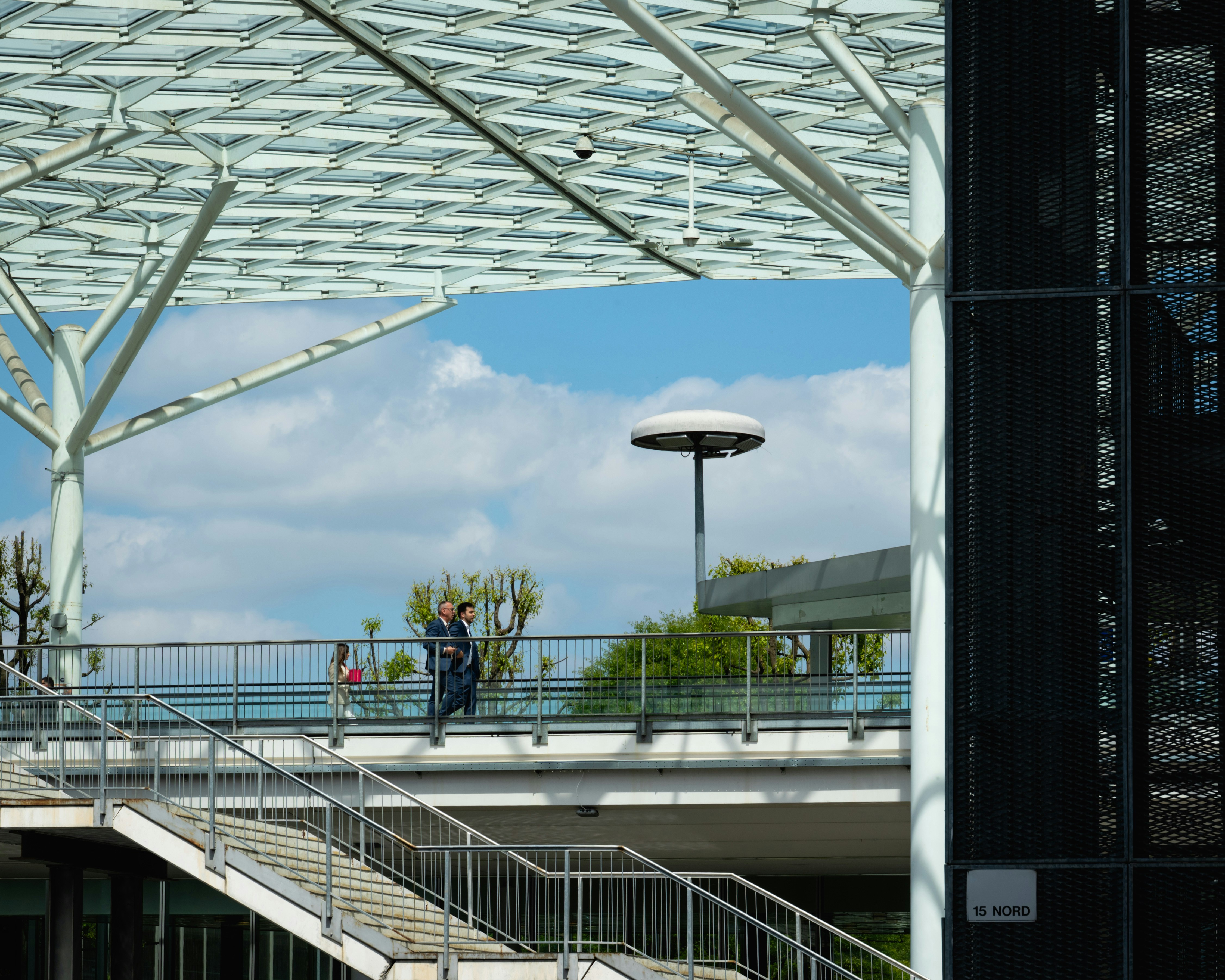 Rooftop Moment: People on a Skybridge