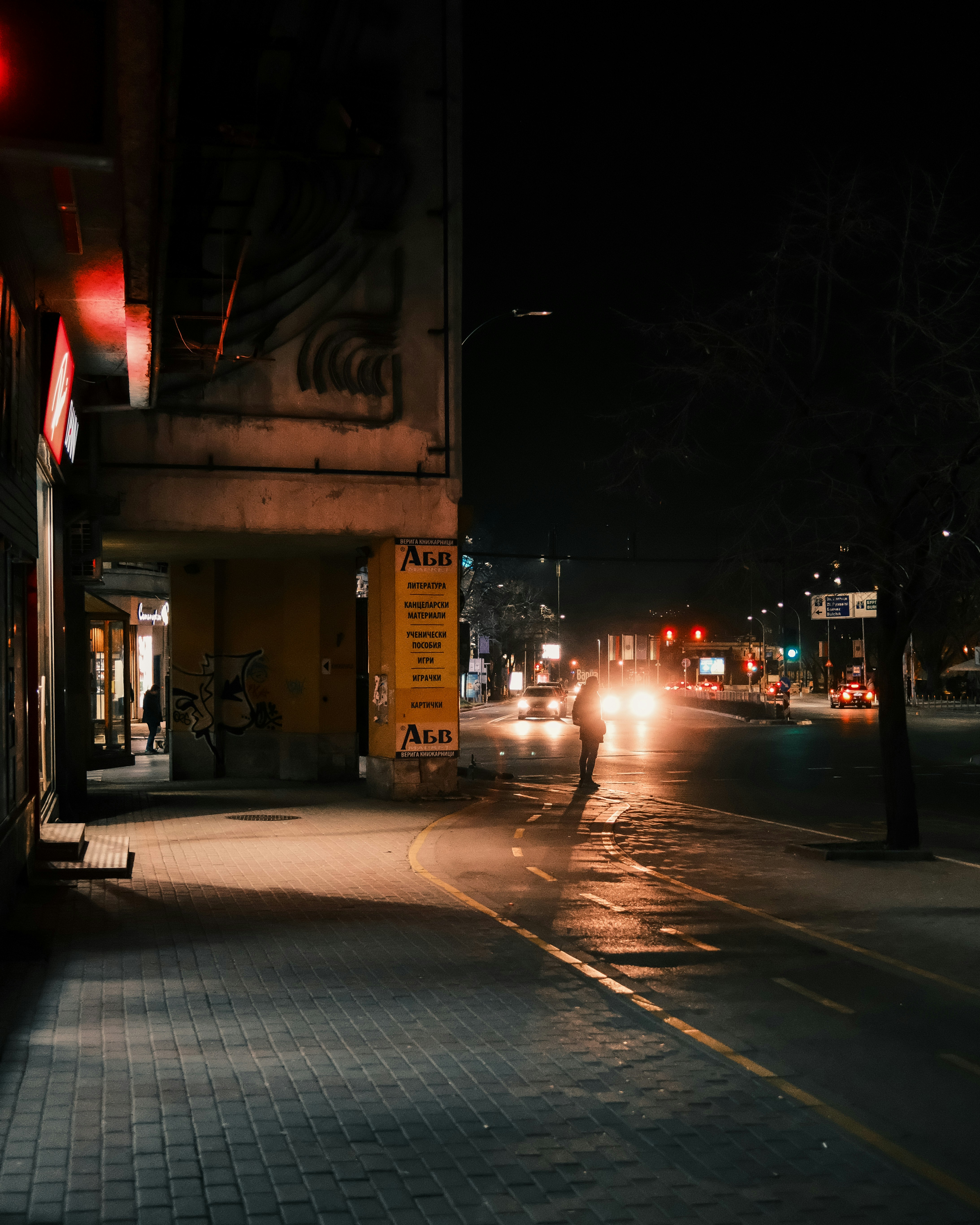 Night Street Corridor: Neon Edge and Oncoming Headlights