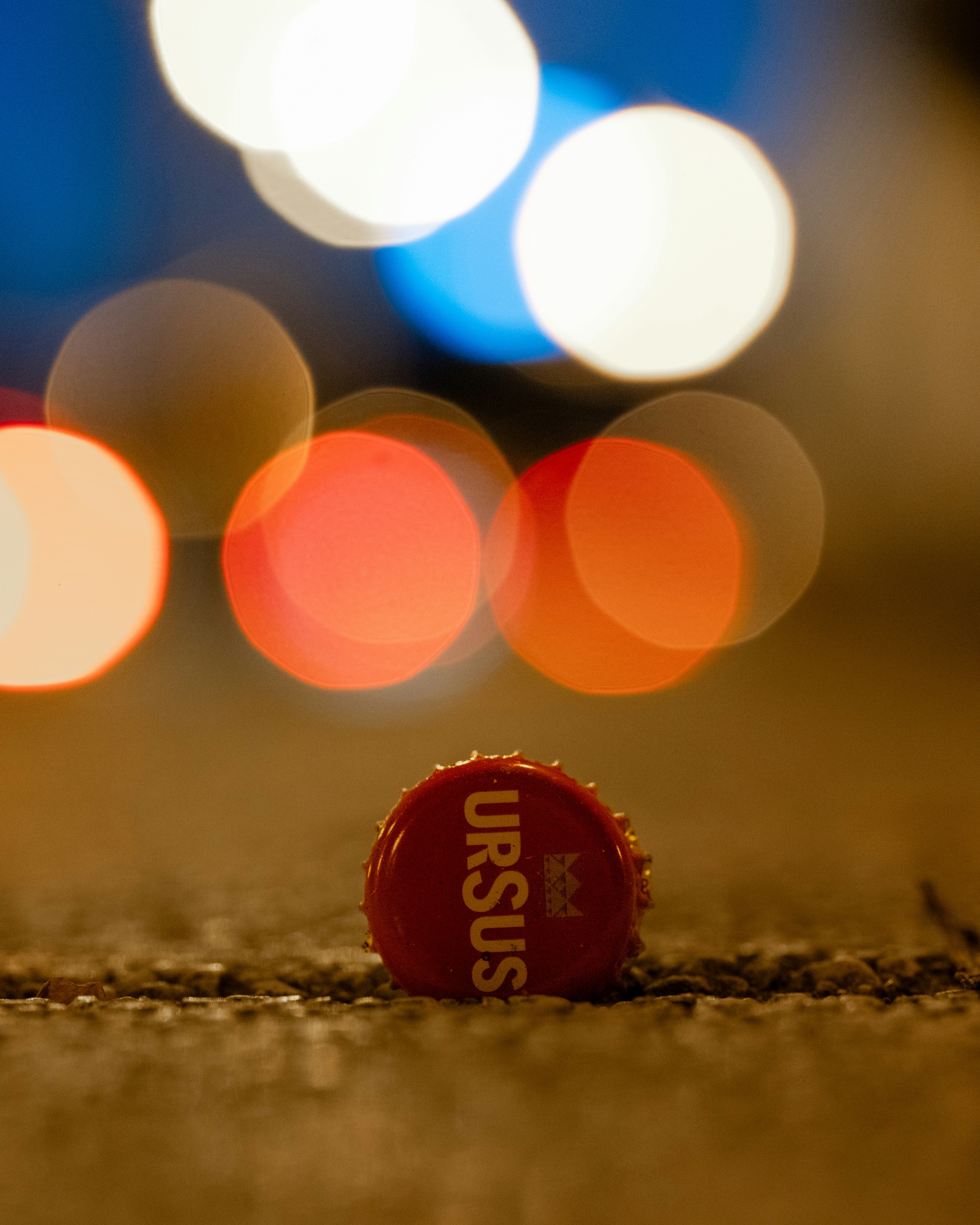 Bottlecap in City Glow: A Night Scene Focused on a Single Stopper