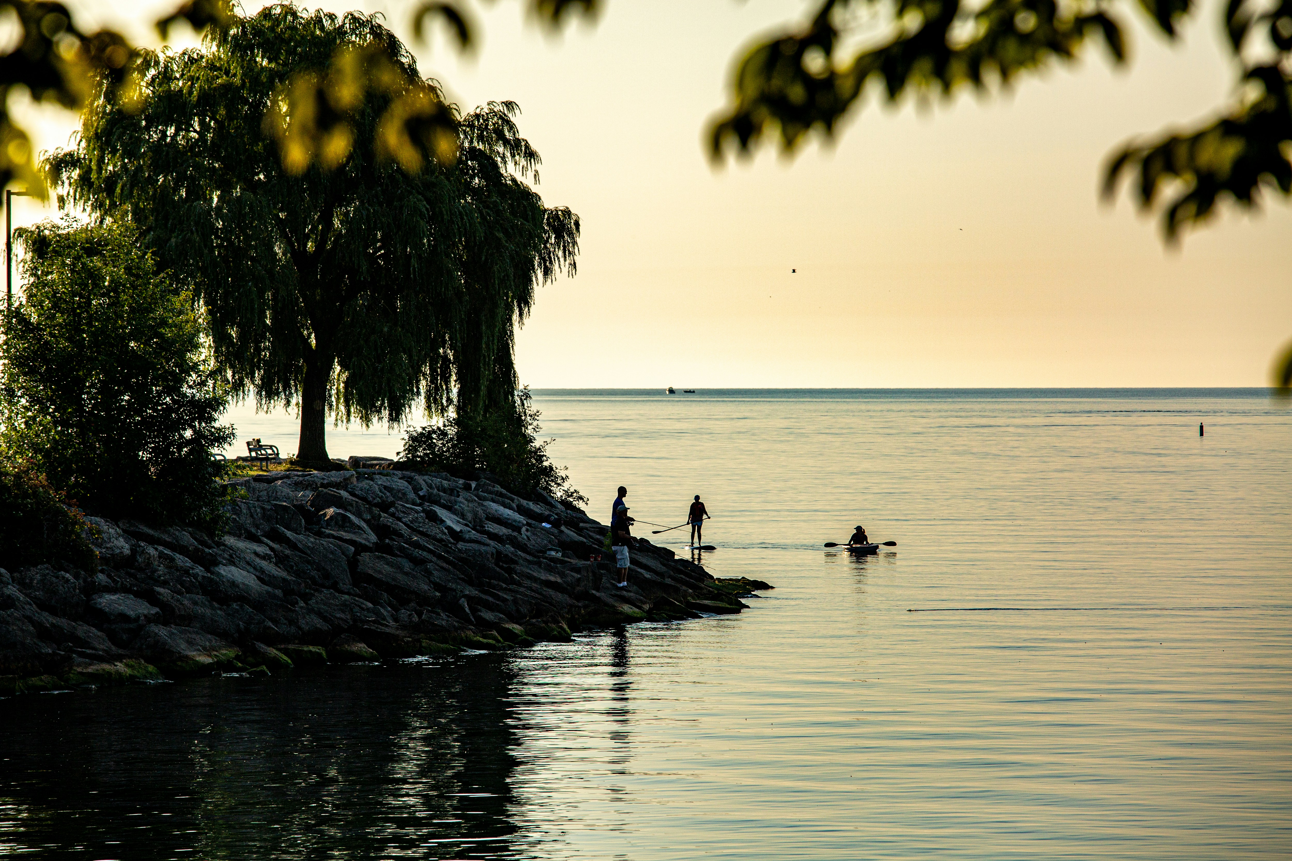 Sunset at the Jetty: Quiet Figures by the Shore