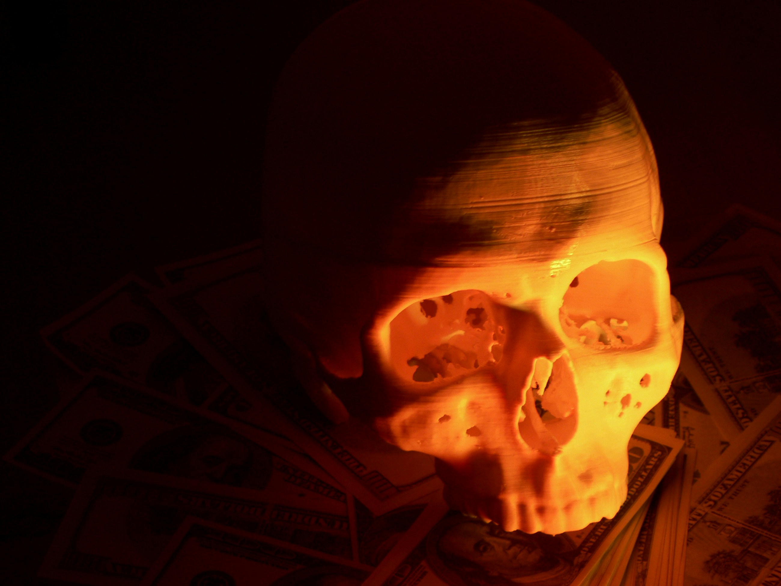 Underlit Skull Emerges from Hidden Cards