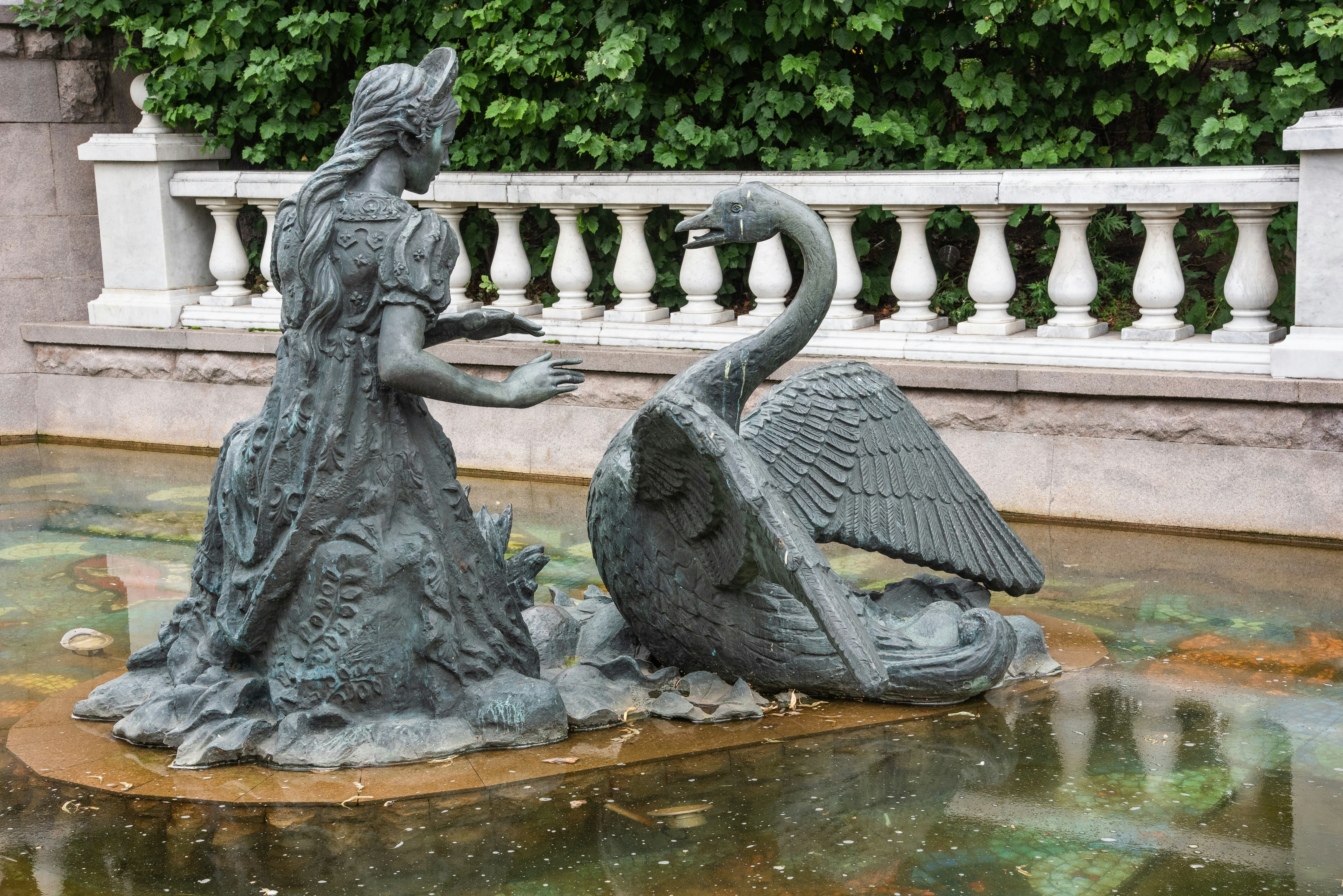A Quiet Exchange: Maiden and Swan in Garden Fountain
