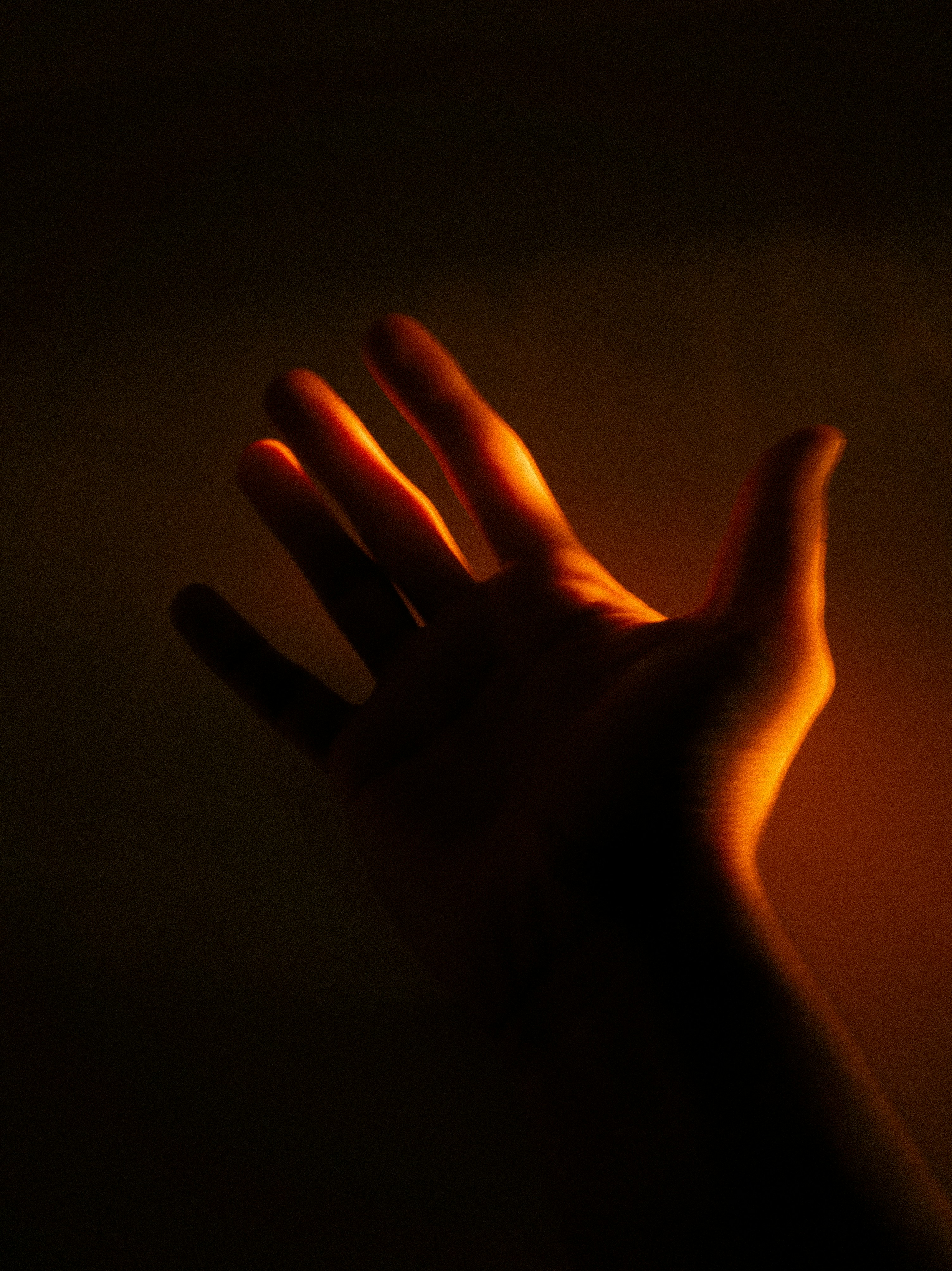 Warm Hand in Darkness: A Silhouette of Light on the Palm