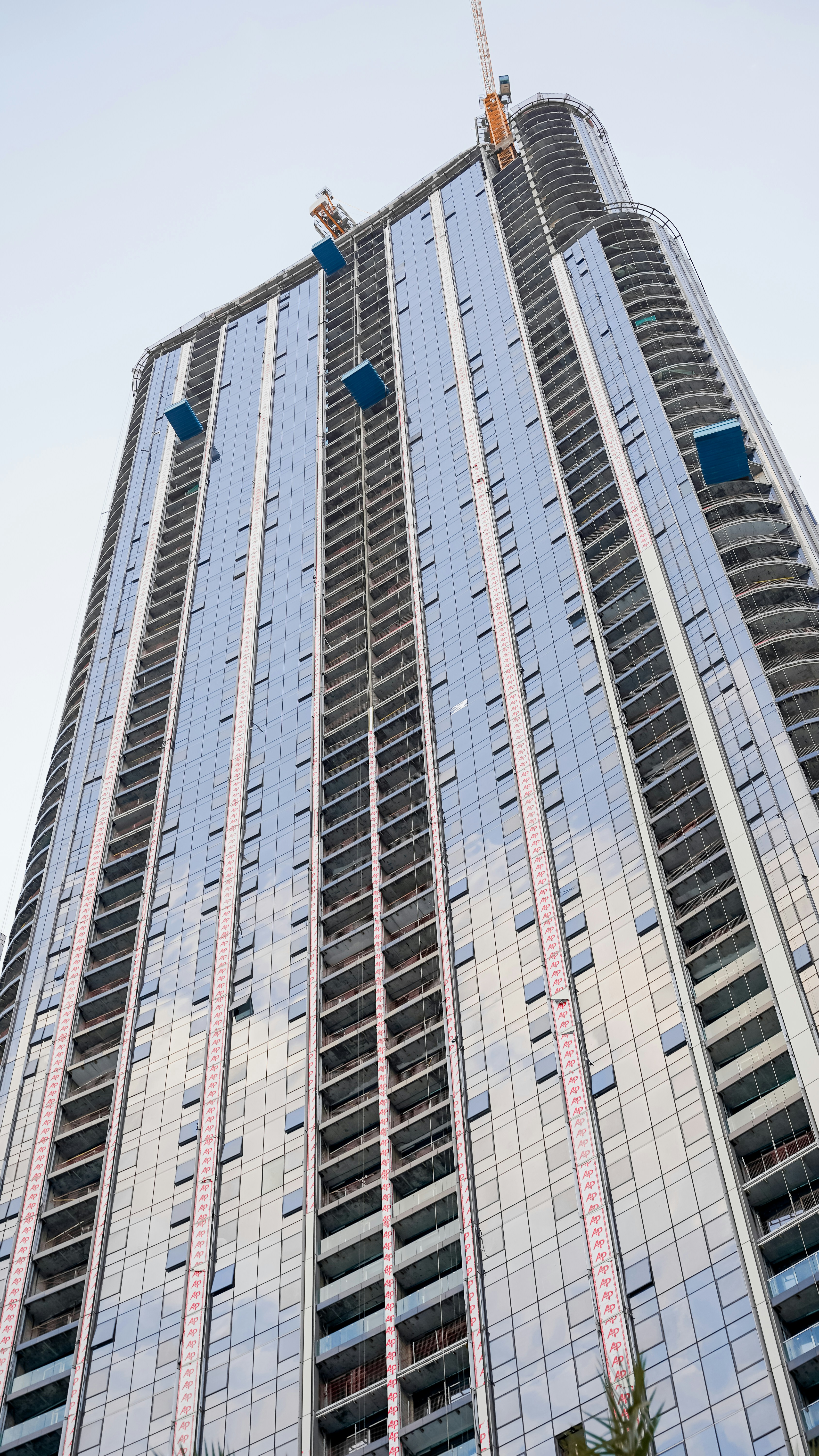 Skyward Facade: Cranes and Glass Towers in Construction