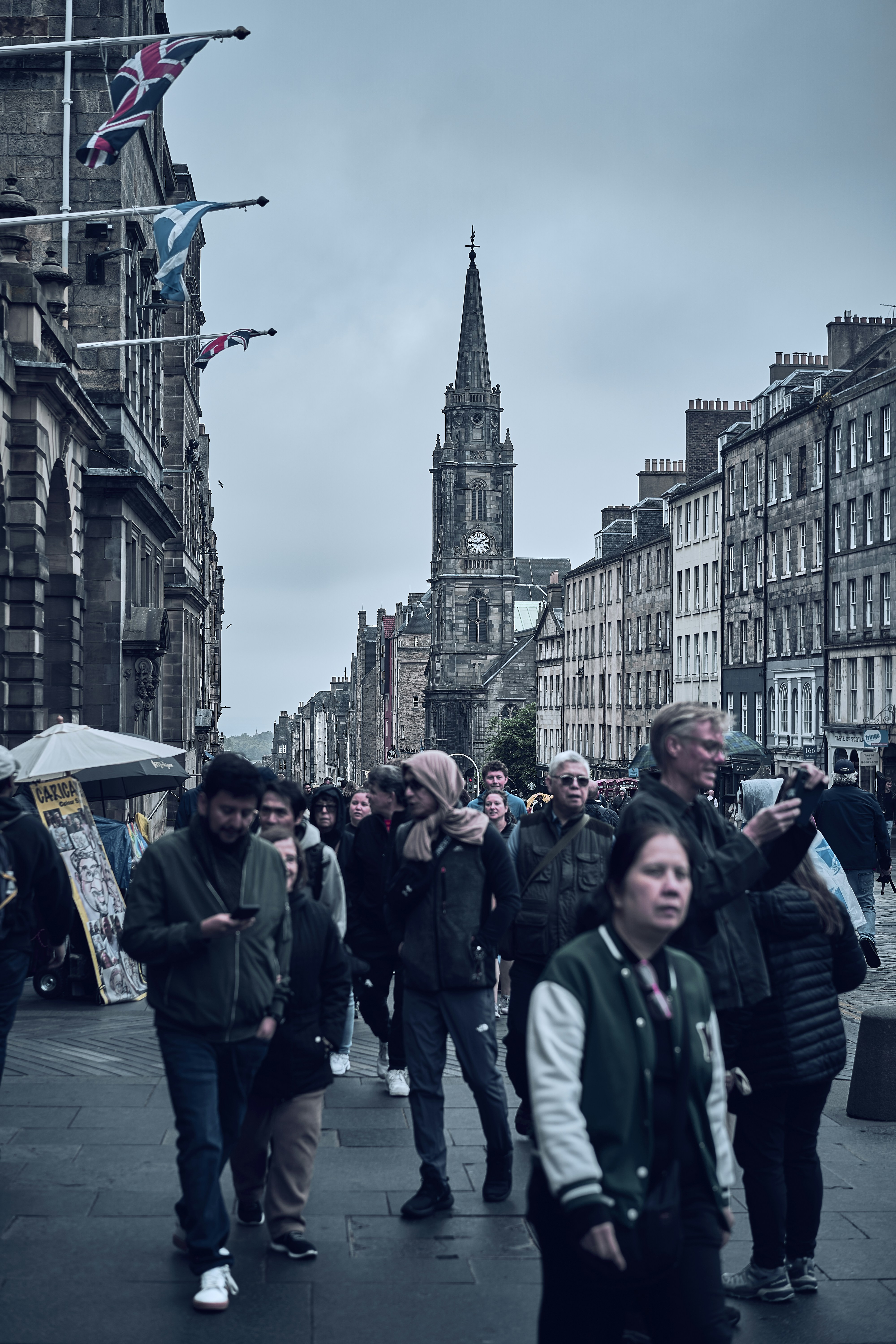 Crowd in a Historic Street Framed by a Clock Tower