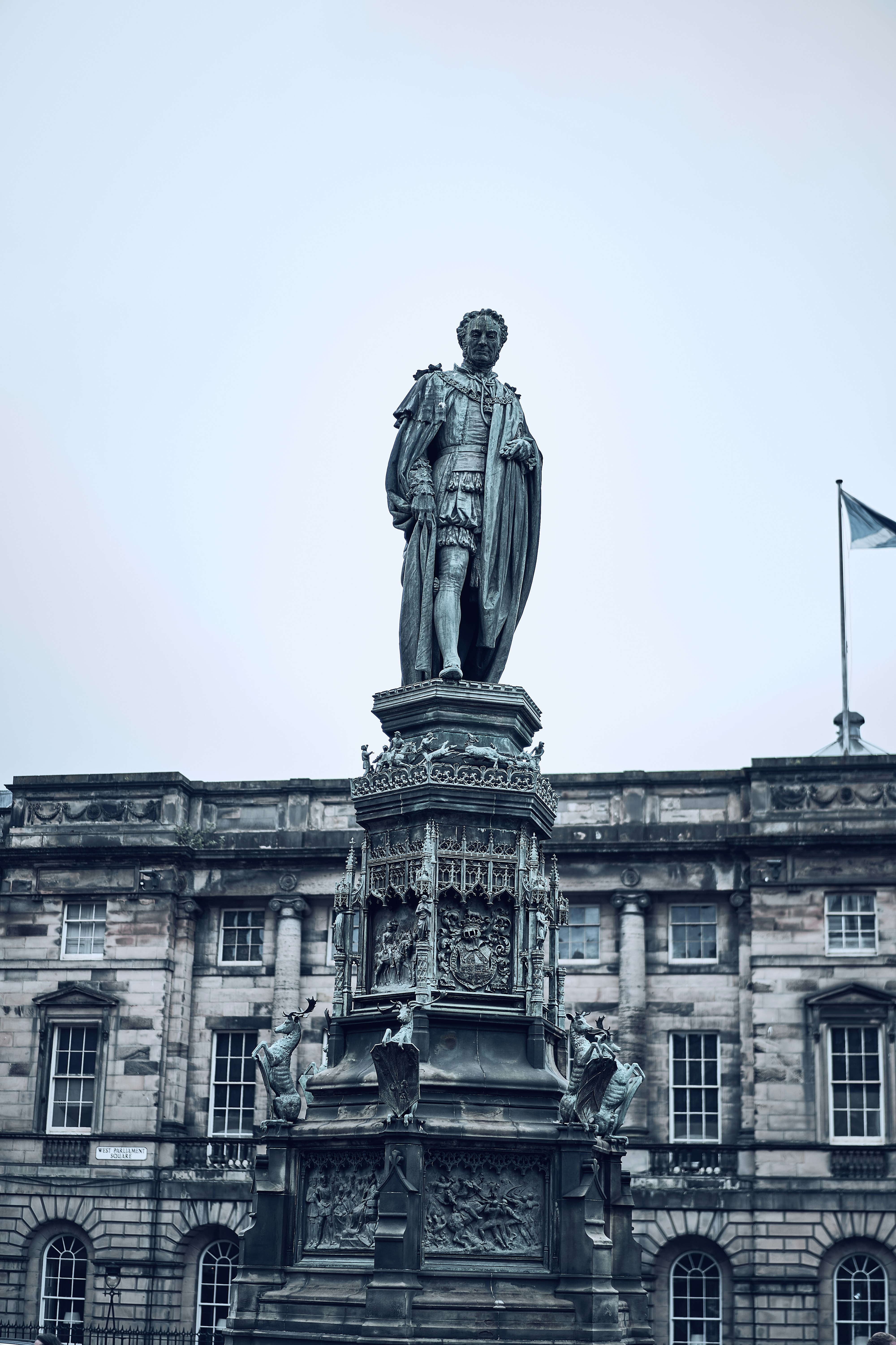 Statue of Valor: A Monumental Figure Rising Above an Ornate Pedestal