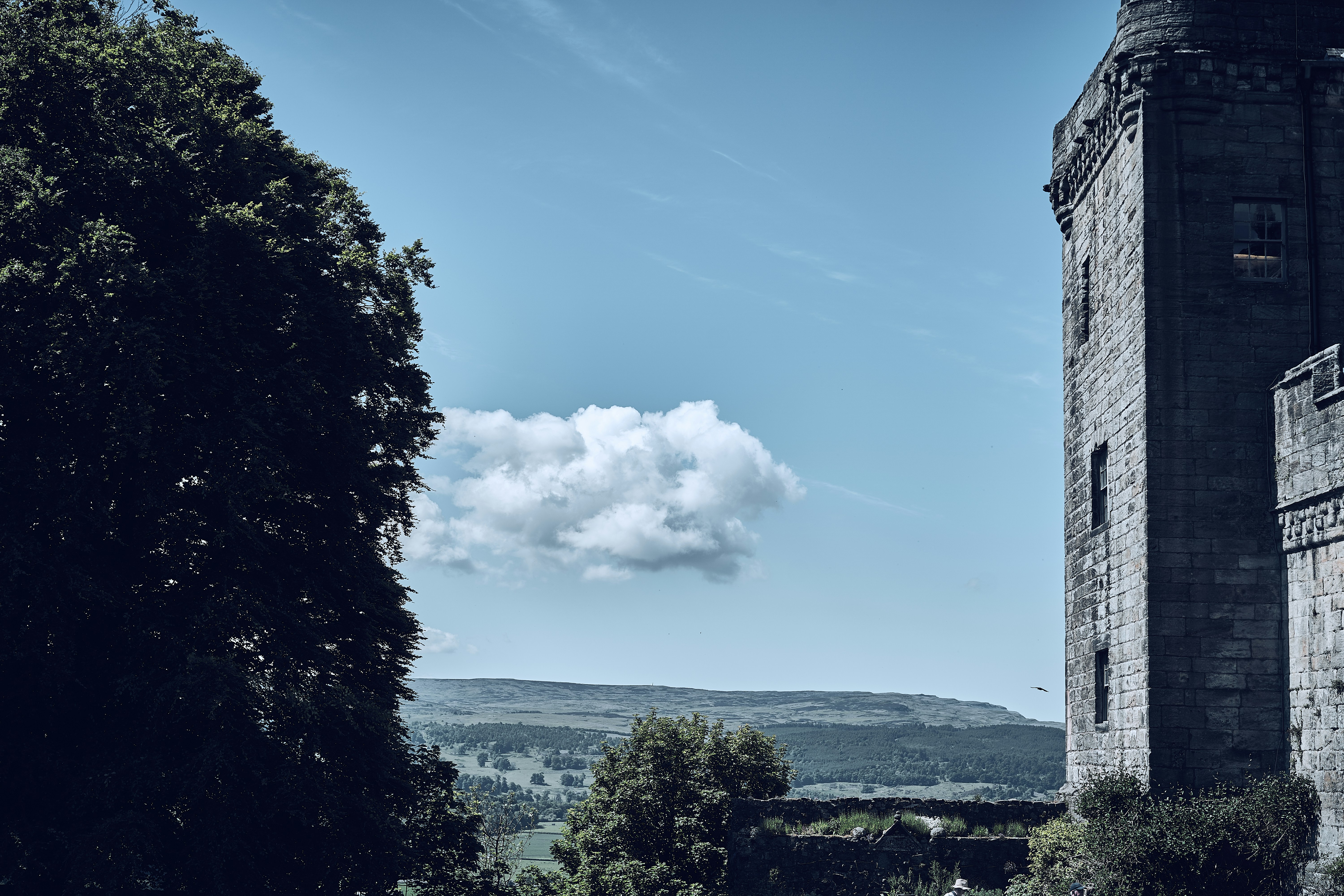Stone tower and sweeping landscape under a blue sky
