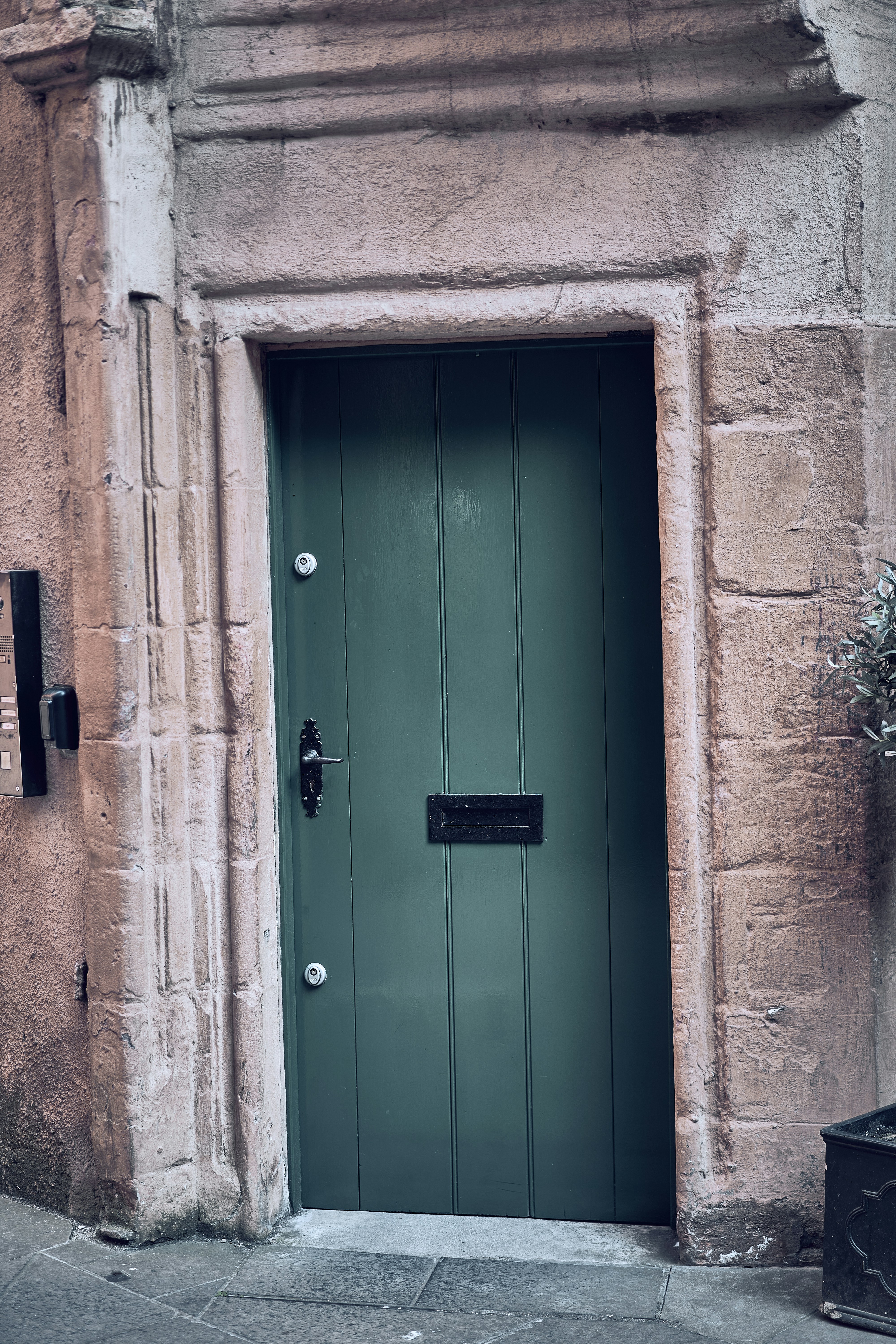 Green door in a weathered stone doorway