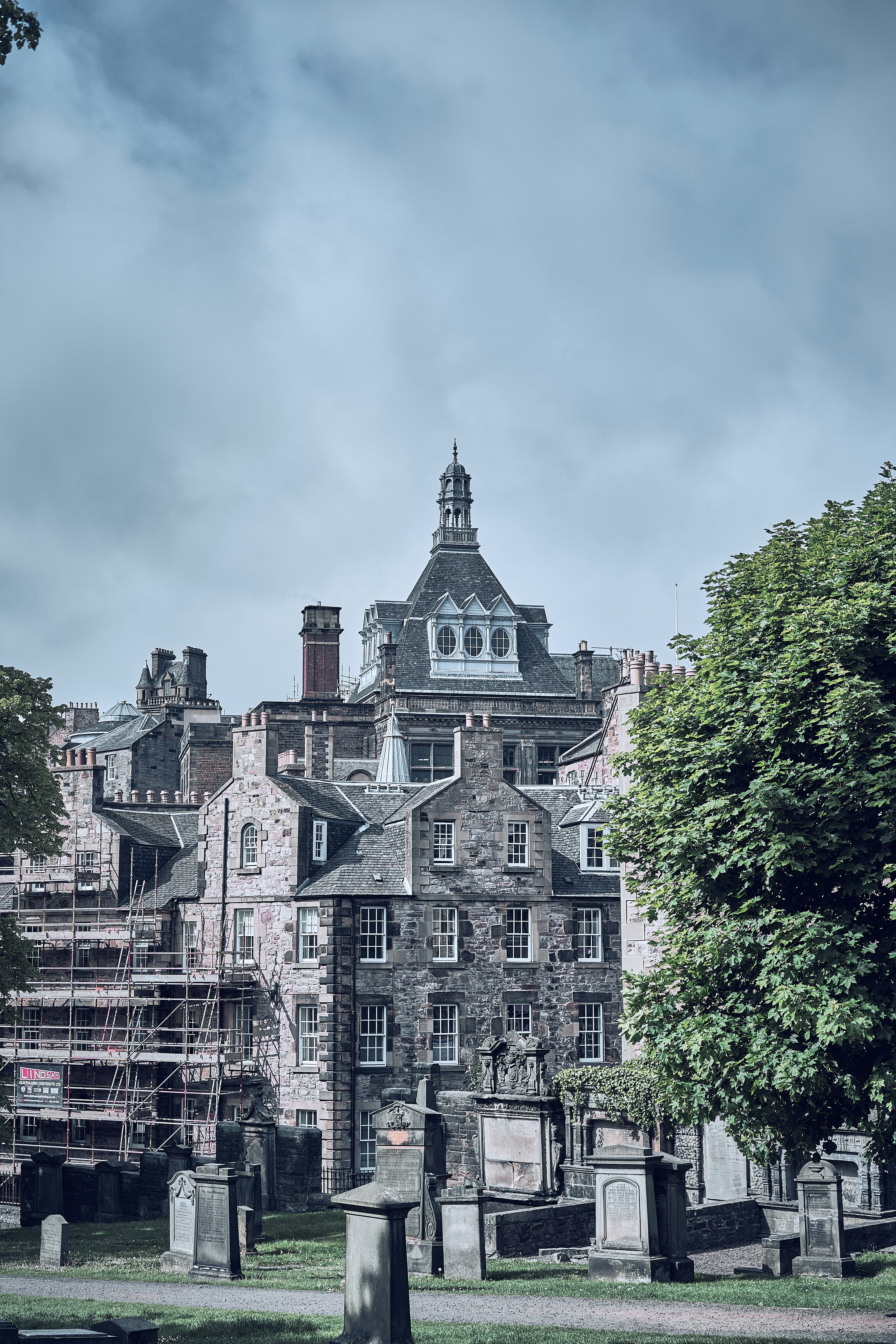 Stone Facade and Tower Amid Historic Cemetery