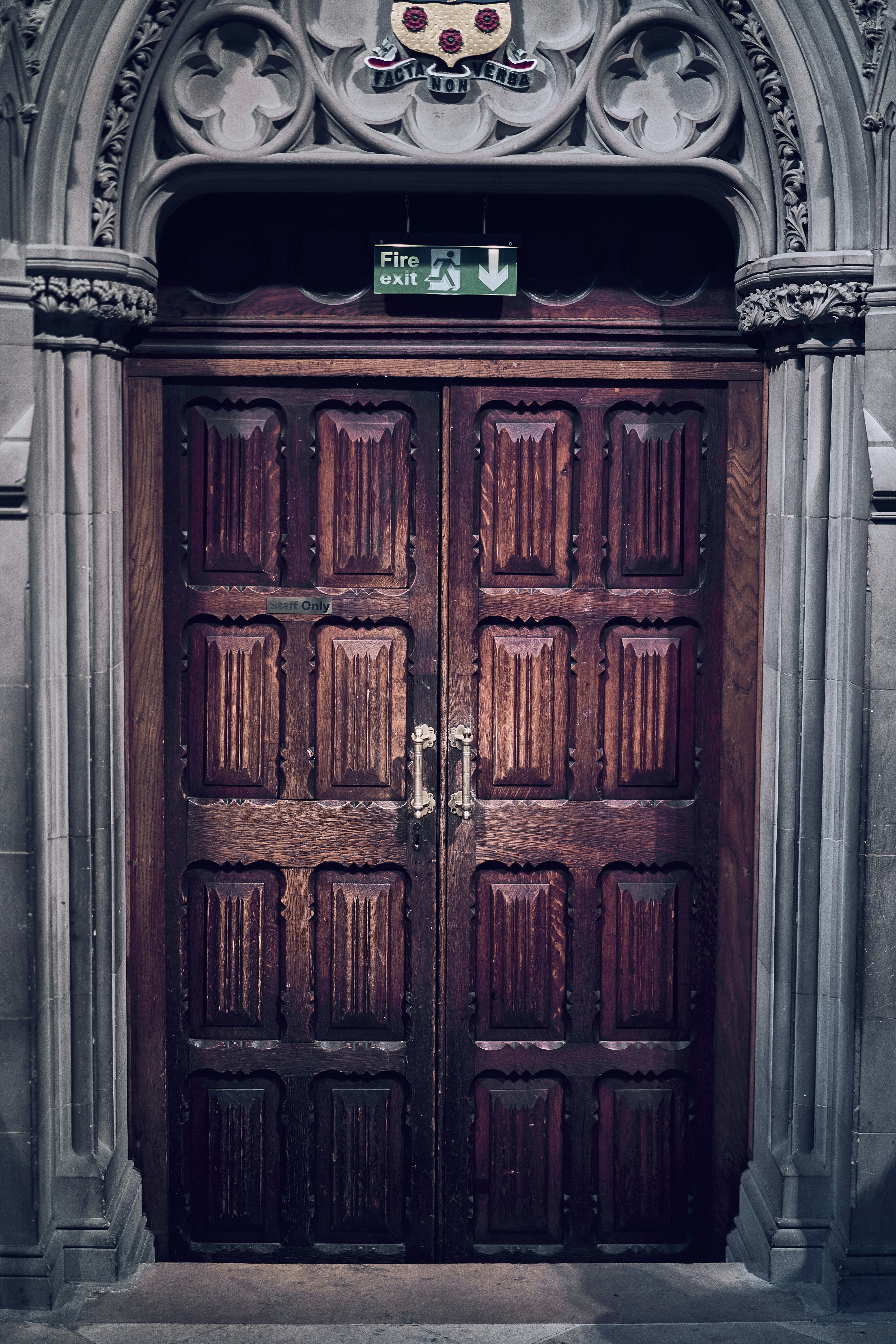 Aged Timber Gate Under Ornate Stone Archway