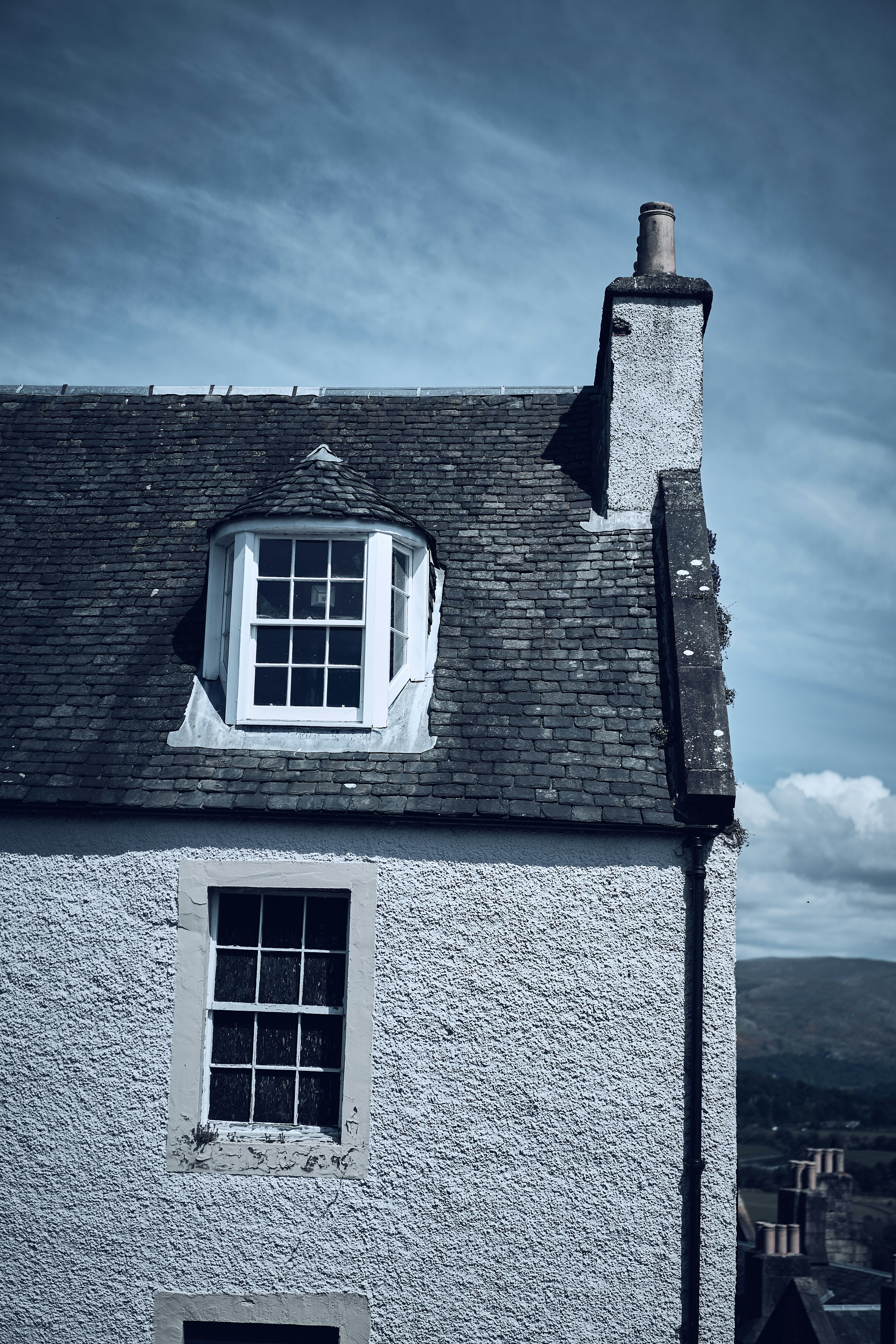 Chalet Roofline with Dormer Window under a Vast Sky