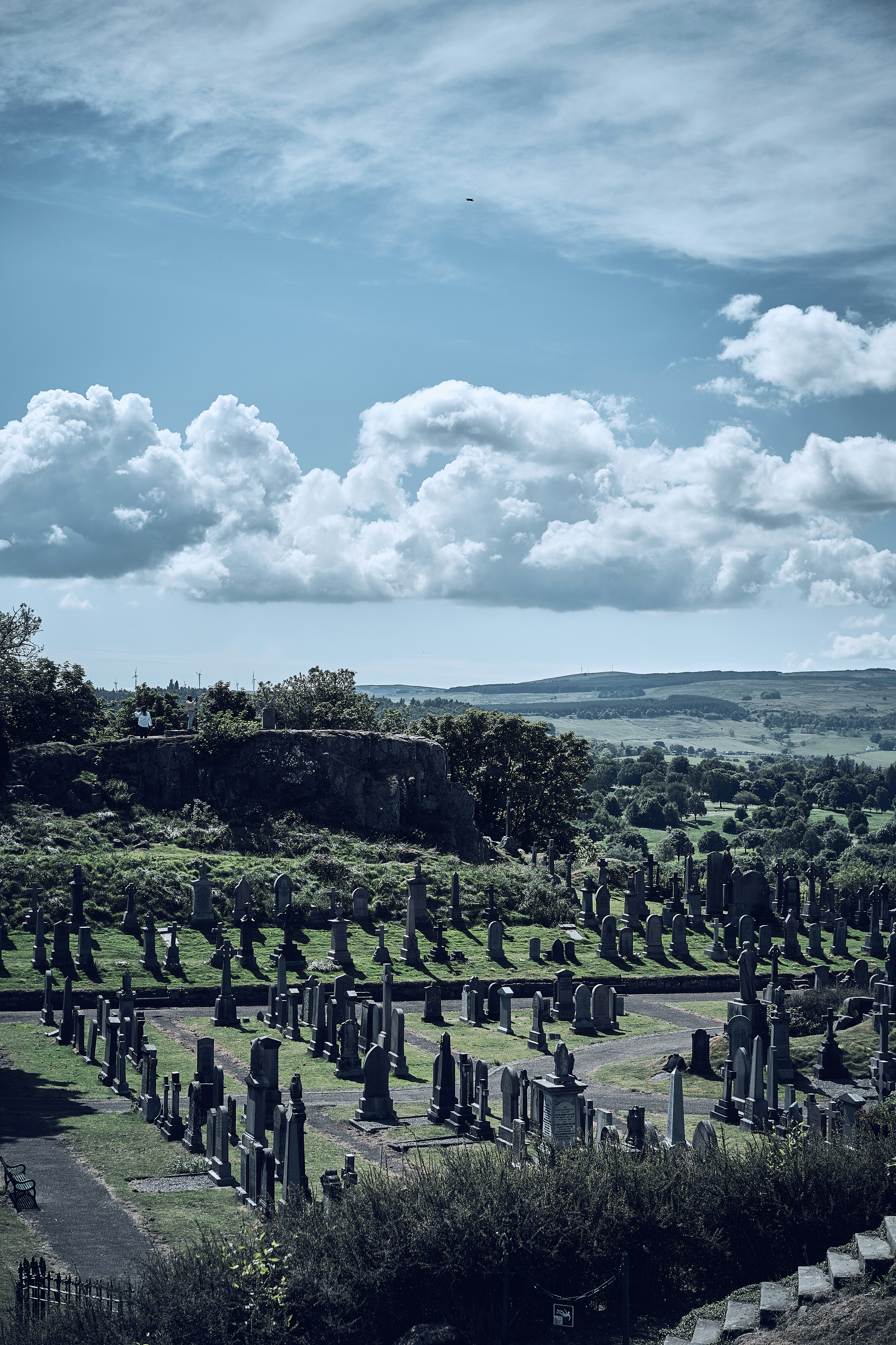 Rows of Stone Echoes: A Sloped Cemetery Beneath a Vast Sky