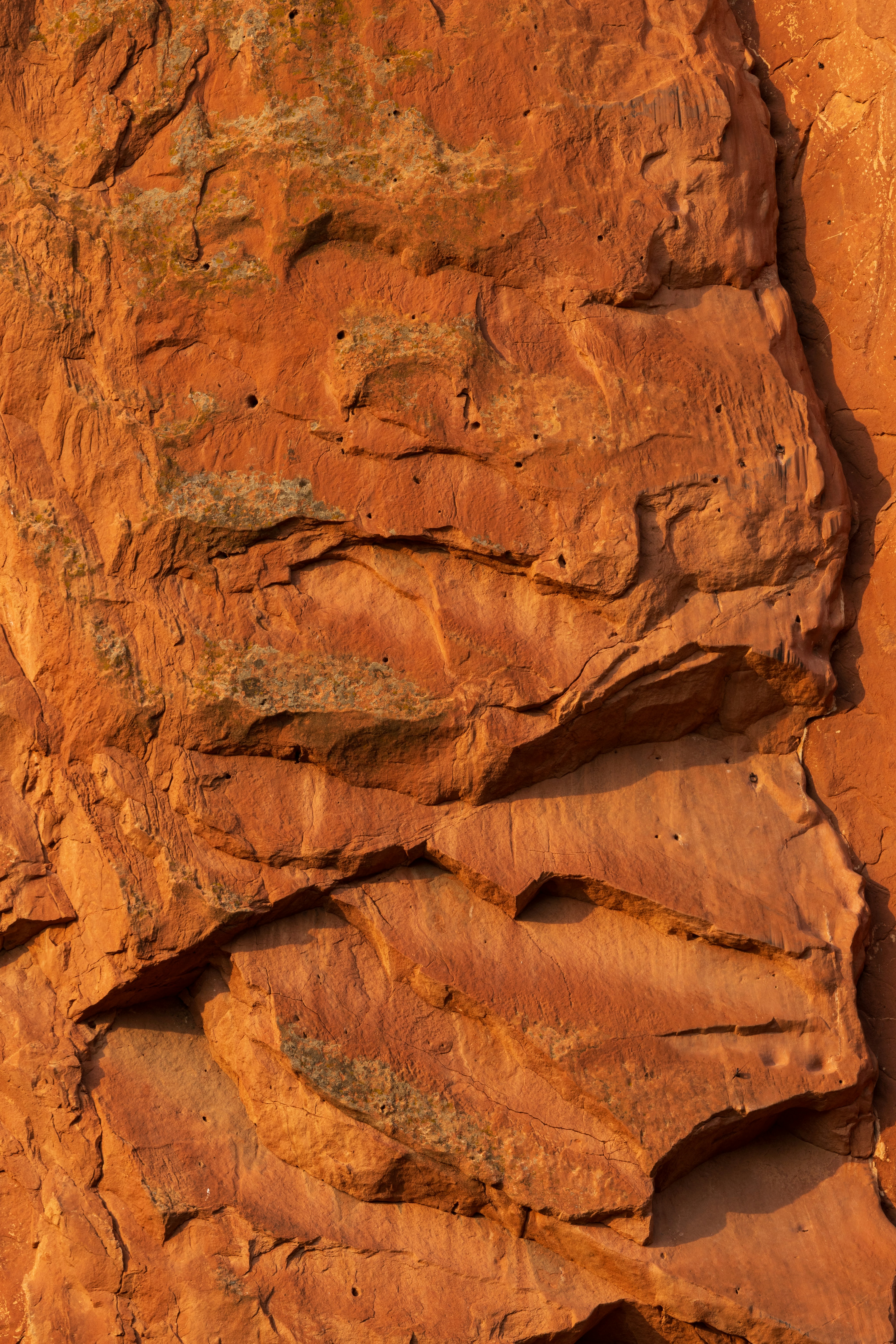 Rust-Red Canyon Facade: Strata and Shadows in Sunlit Rock