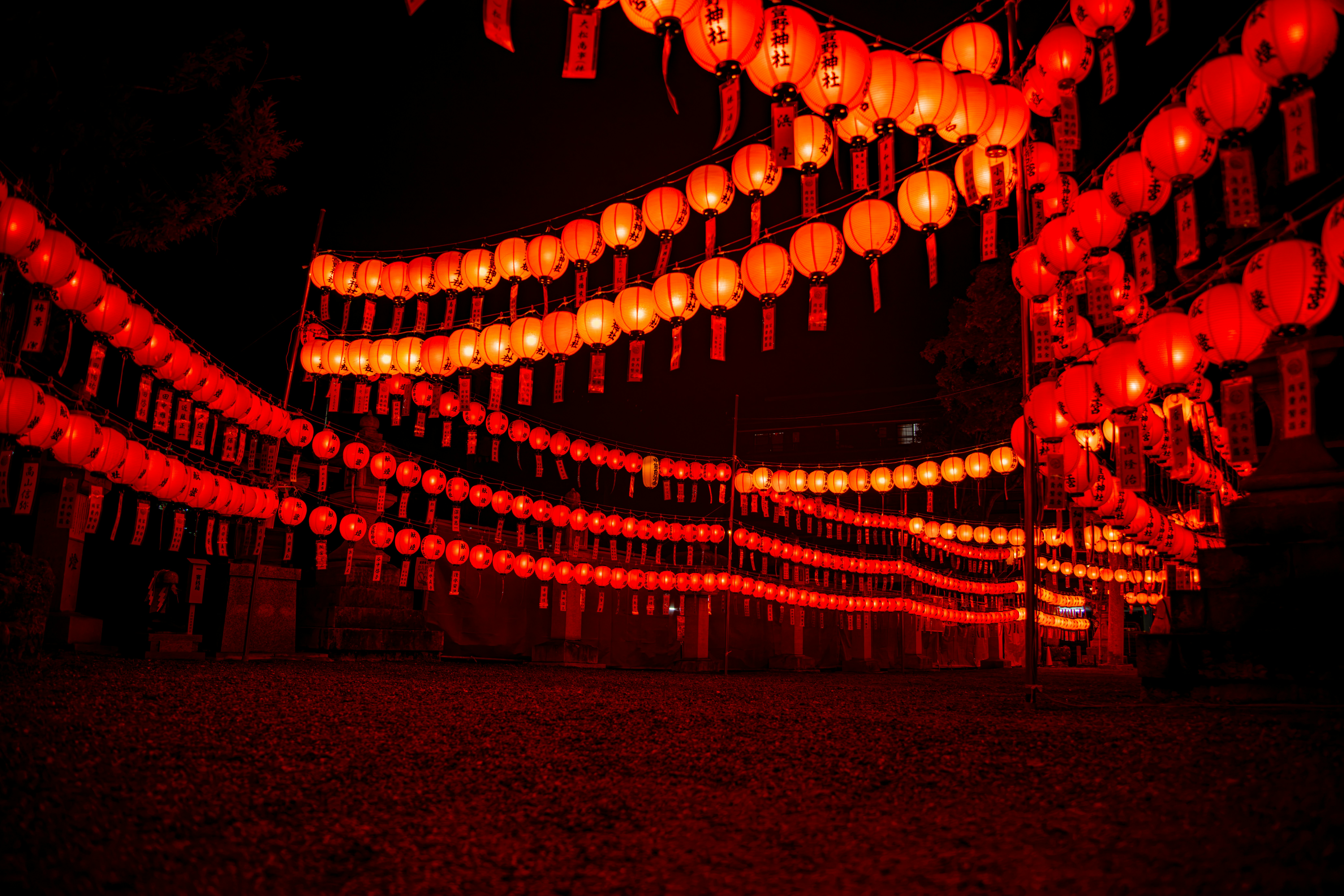 Red Lantern Cascade Over a Darkened Lawn