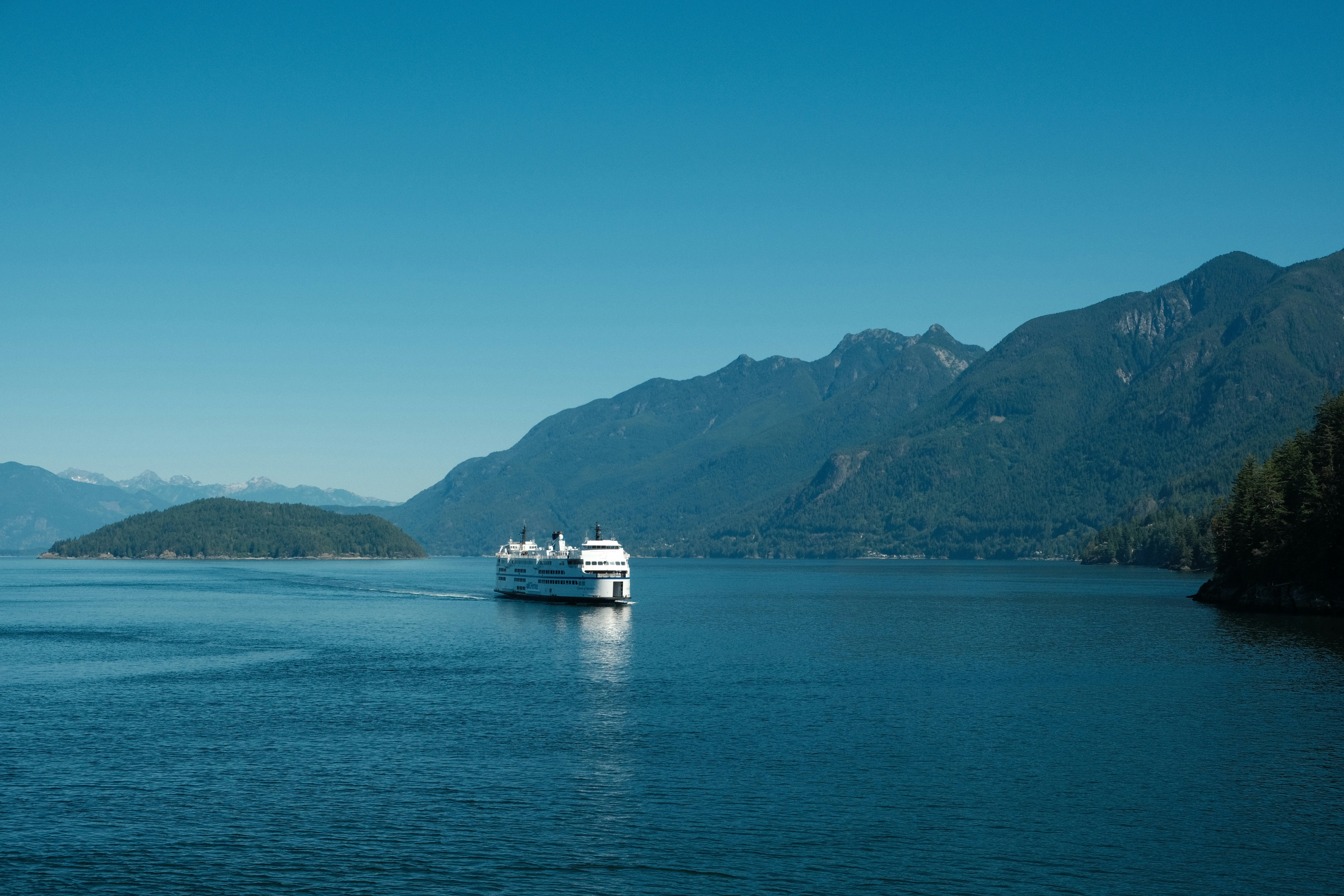 Translucent Blue Corridor: A Passenger Vessel Confronts Fjord Majesty